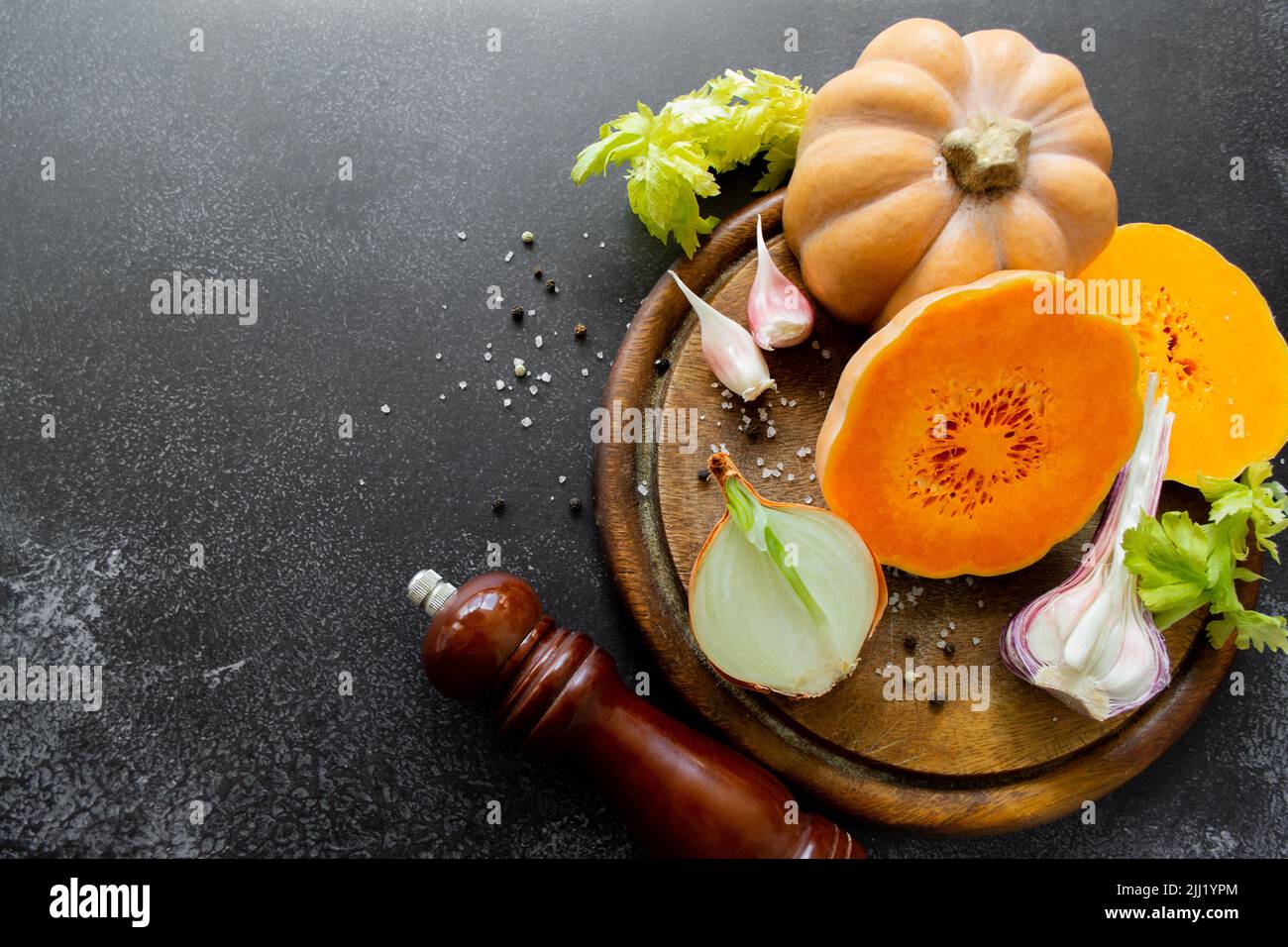 Vegetables: orange squash with garlic and onions. Spice mill, pepper ...