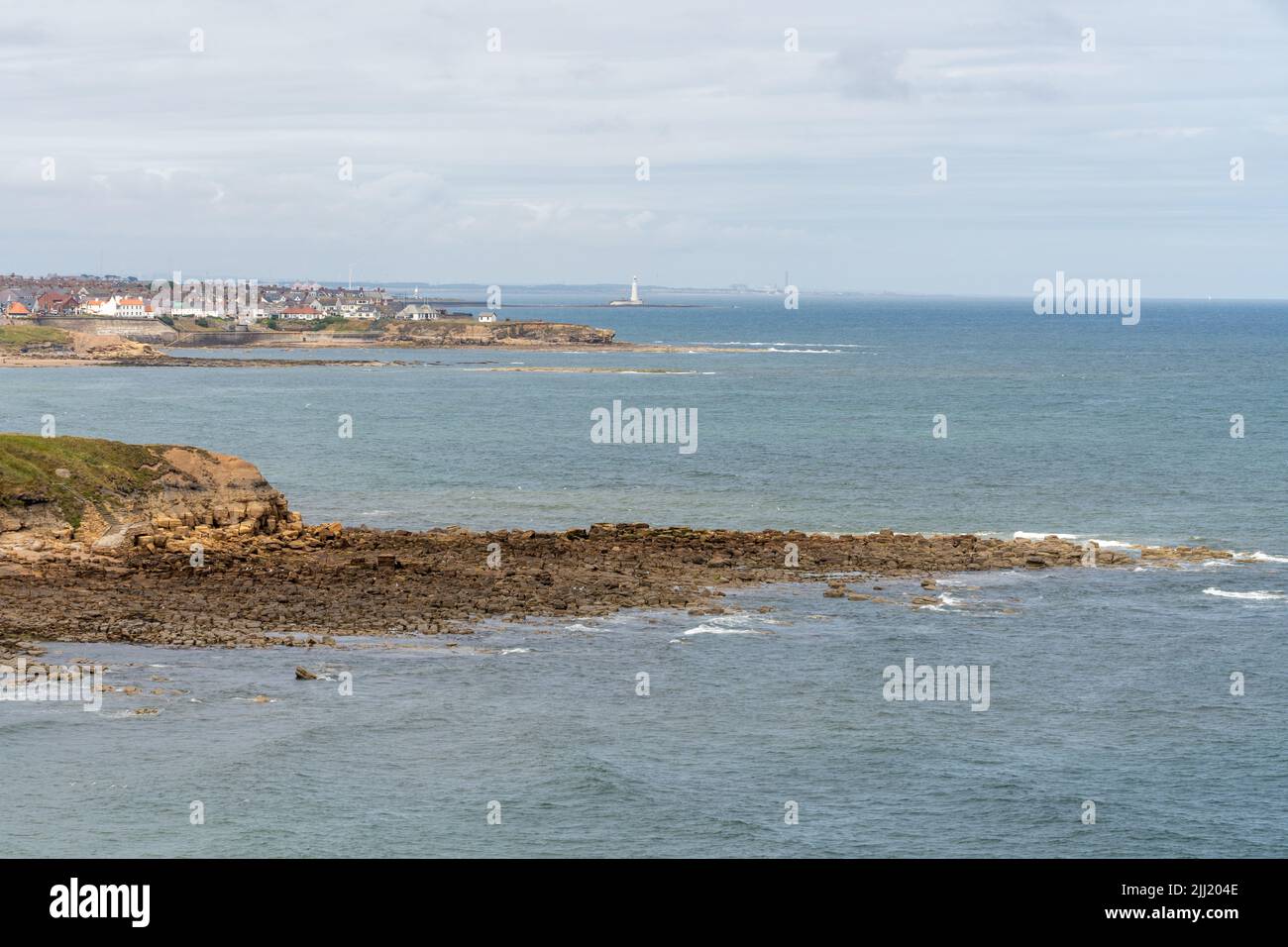 The view over rocks at King Edward's Bay, Tynemouth, North Tyneside, UK ...