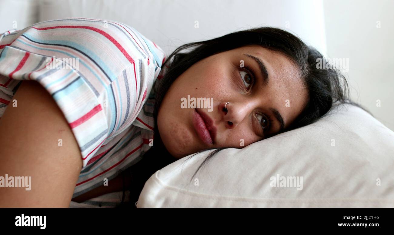 Pensive woman taking a deep breath. Sad girl sighing at home Stock ...