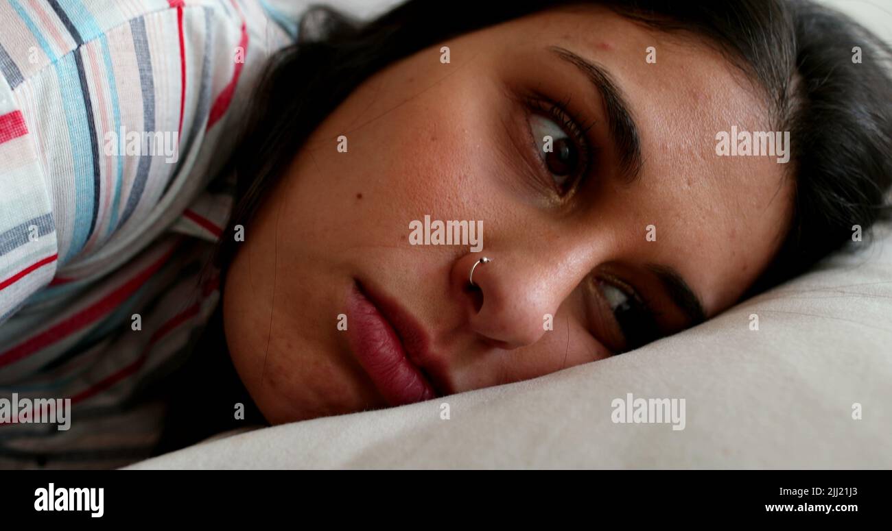 Tired depressed woman lies in couch closing eye to rest Stock Photo - Alamy