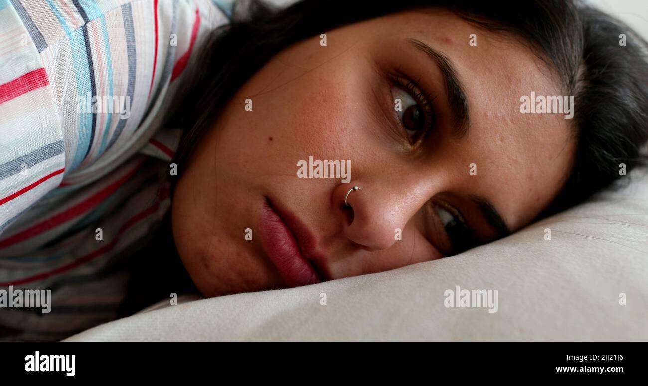 Tired depressed woman lies in couch closing eye to rest Stock Photo - Alamy