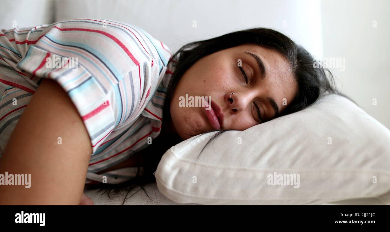 Tired depressed young woman lying in couch feeling sad and regretful ...