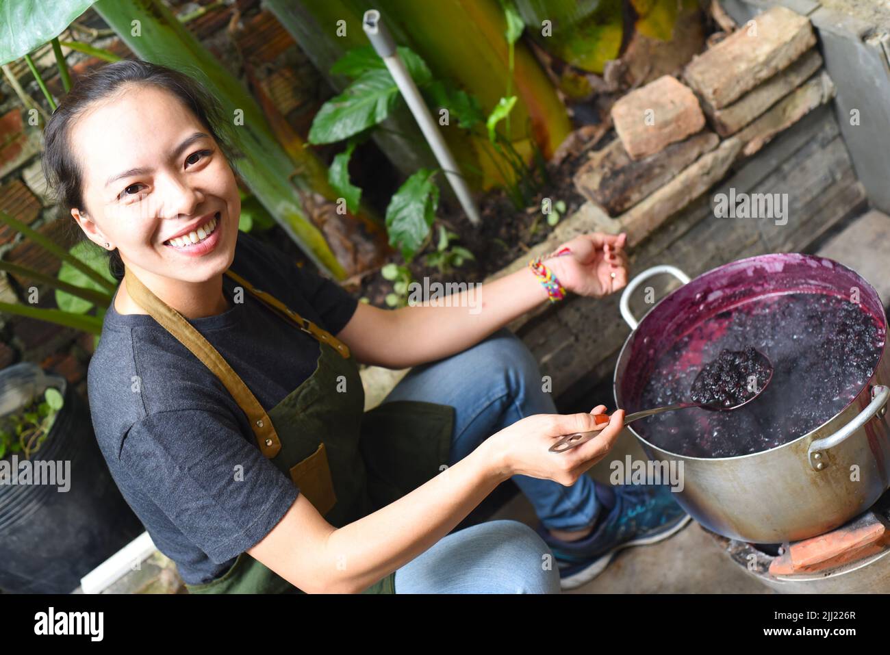 Woman making jam in kitchen hi-res stock photography and images - Alamy