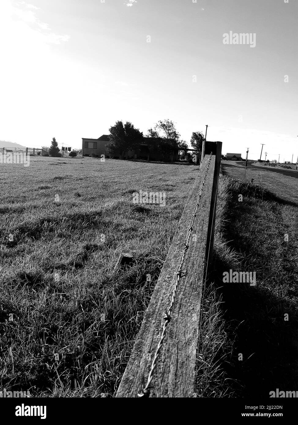 The grayscale of metal wire fence gate in the farmland, vertical Stock ...