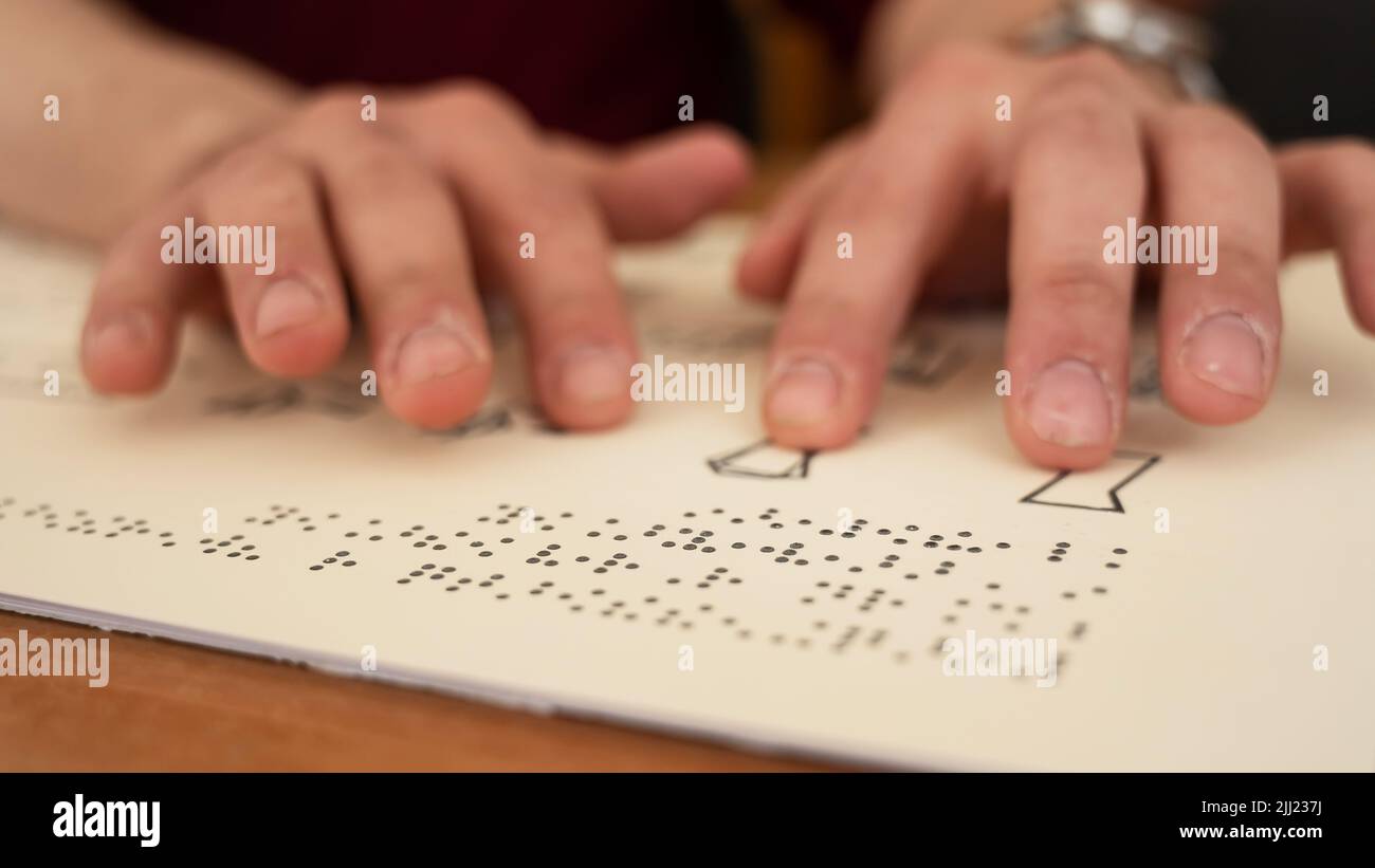 Visually impaired man reading a braille book Stock Photo - Alamy