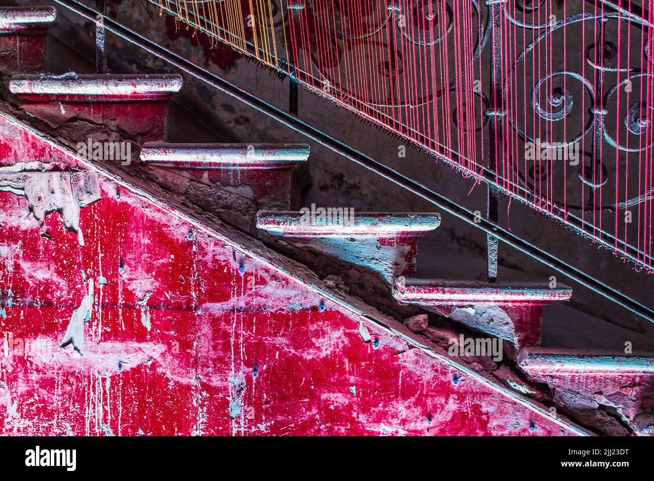 Red concrete staircase with decorative railings, side view, close-up ...