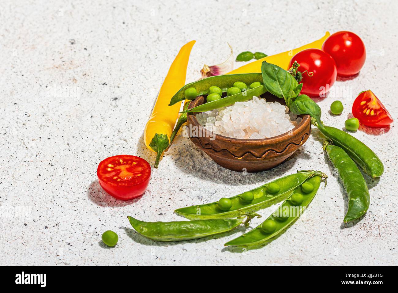 Assorted fresh vegetables and spices on light plaster background. Ripe ...