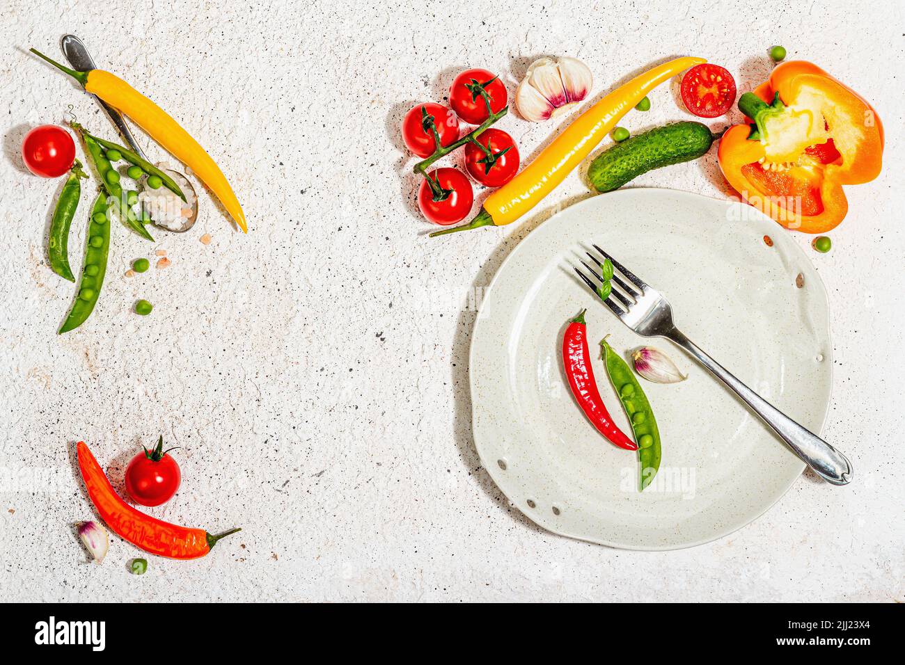 Vegan table setting. Assorted of ripe fresh vegetables, empty plate ...