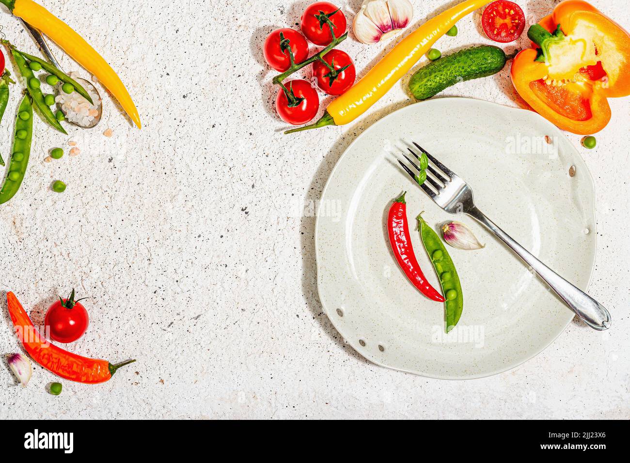 Vegan table setting. Assorted of ripe fresh vegetables, empty plate ...