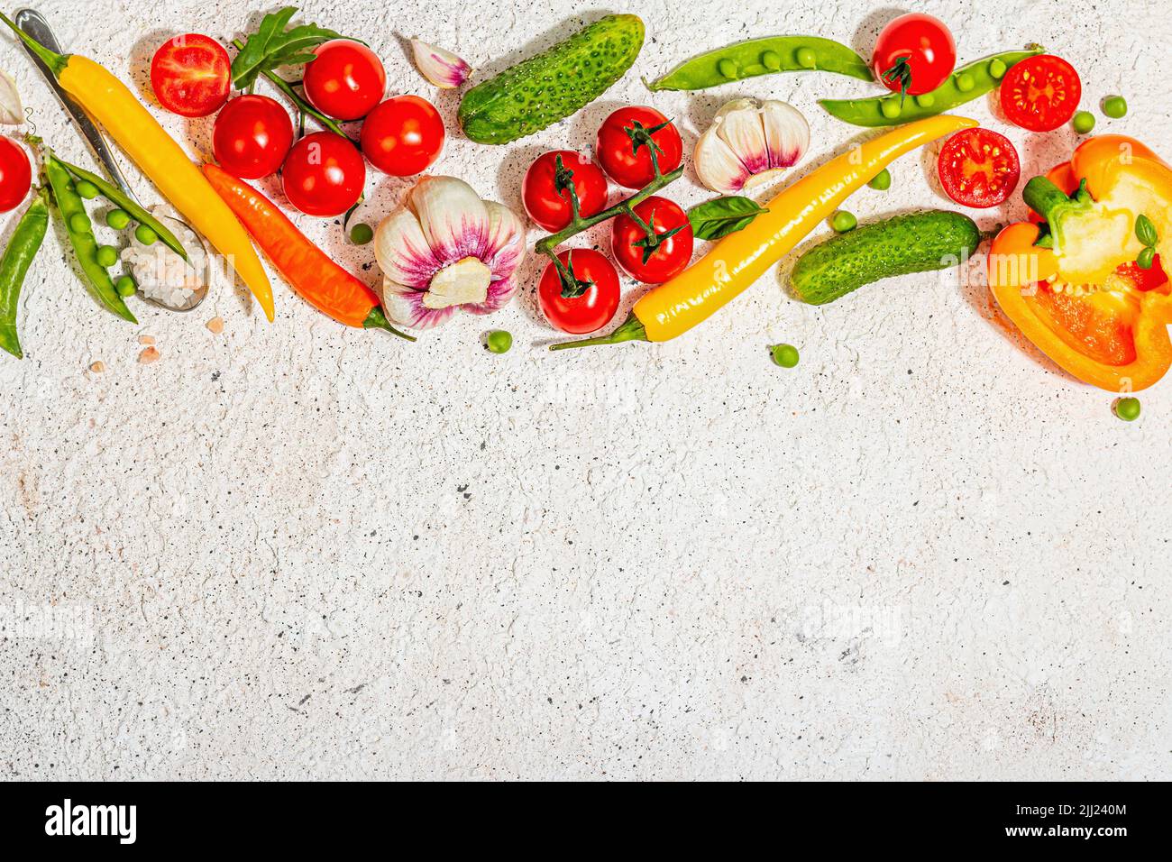 Assorted fresh vegetables and spices on light plaster background. Ripe ...