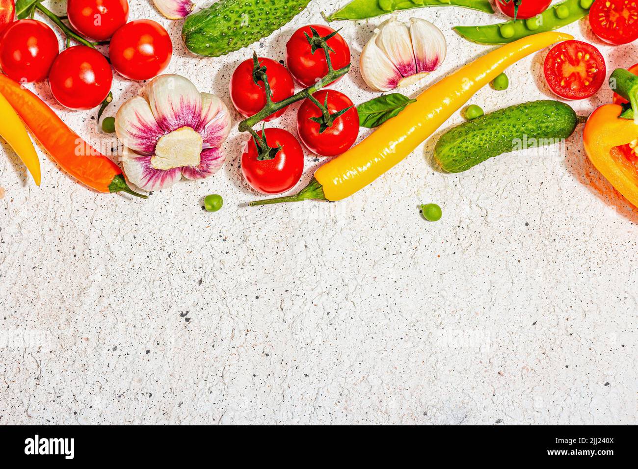 Assorted fresh vegetables and spices on light plaster background. Ripe ...