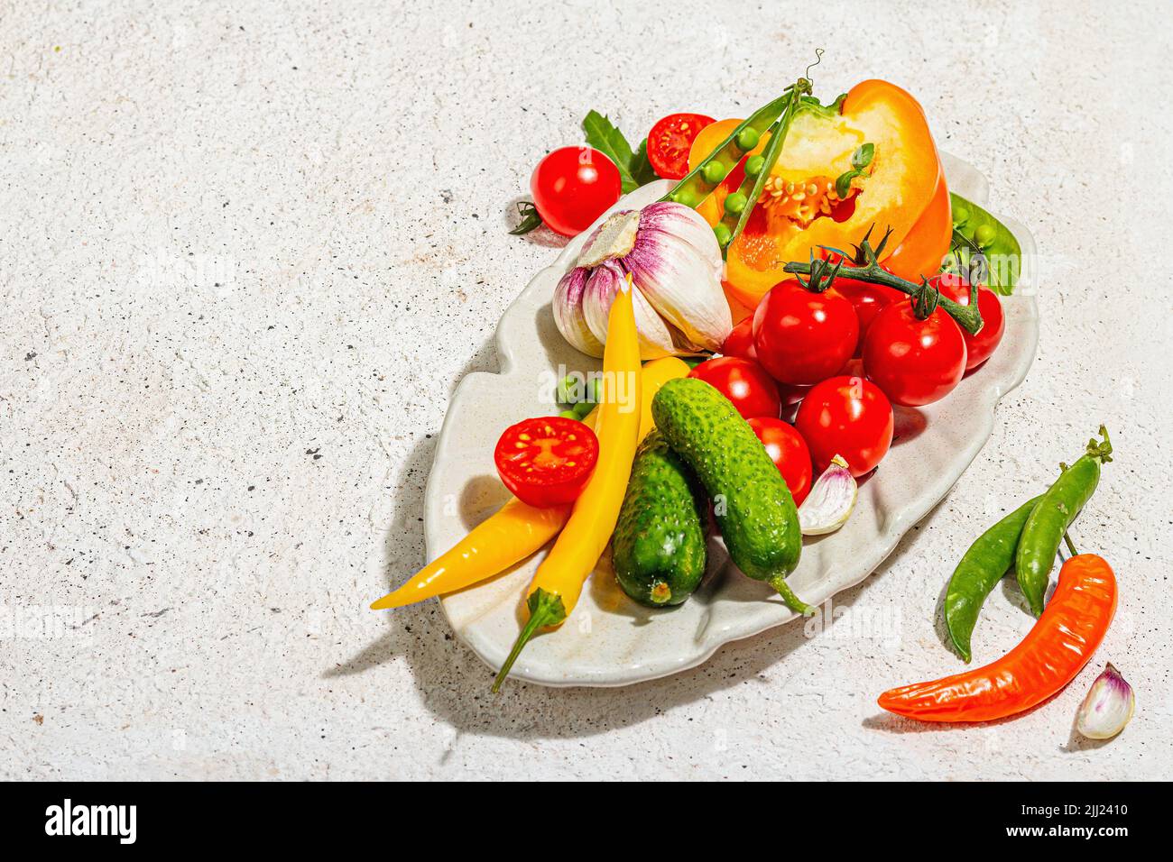 Harvest fresh vegetables on a serving plate. Vegan food concept, trendy ...