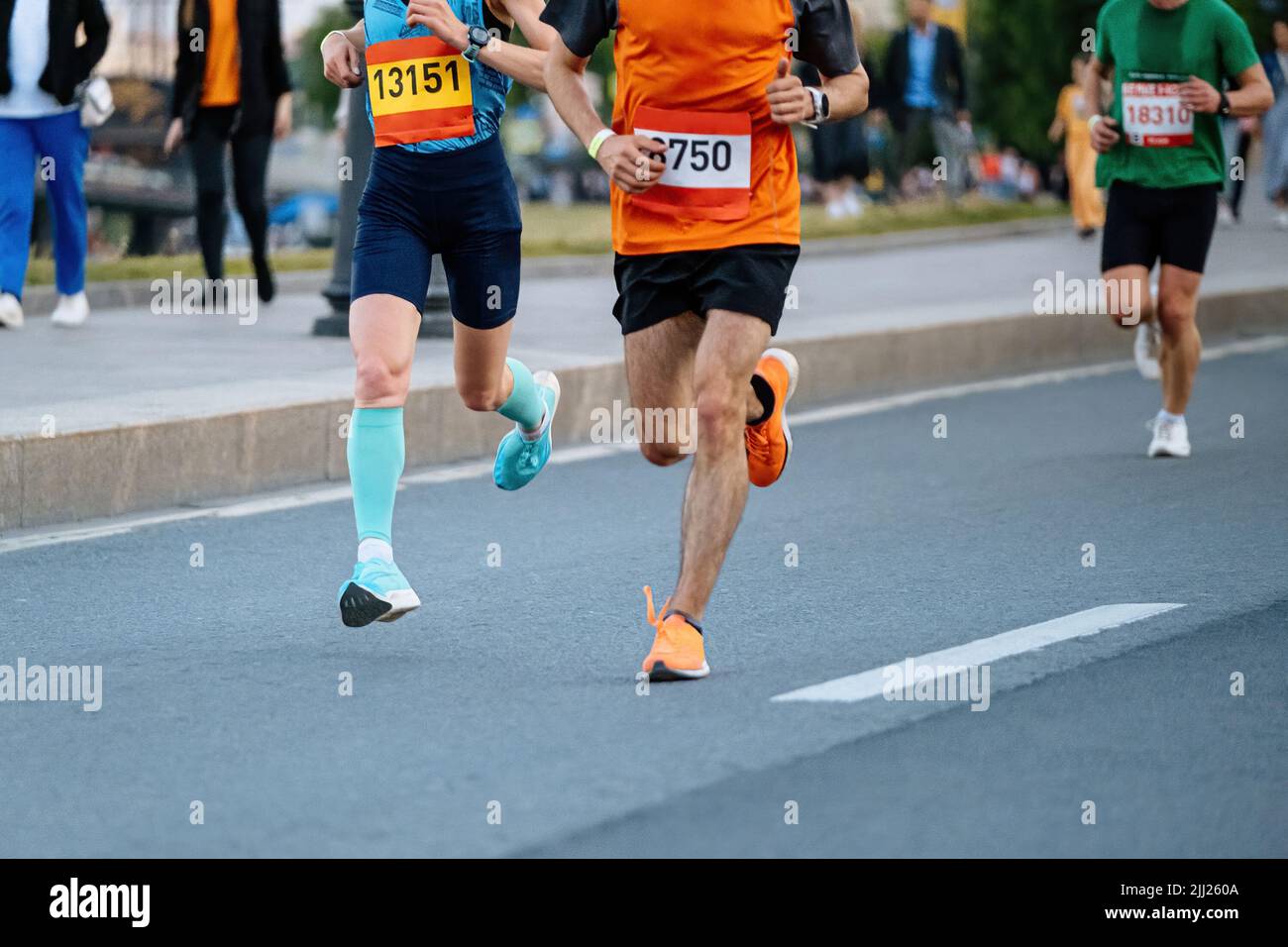 male runners run city marathon Stock Photo - Alamy