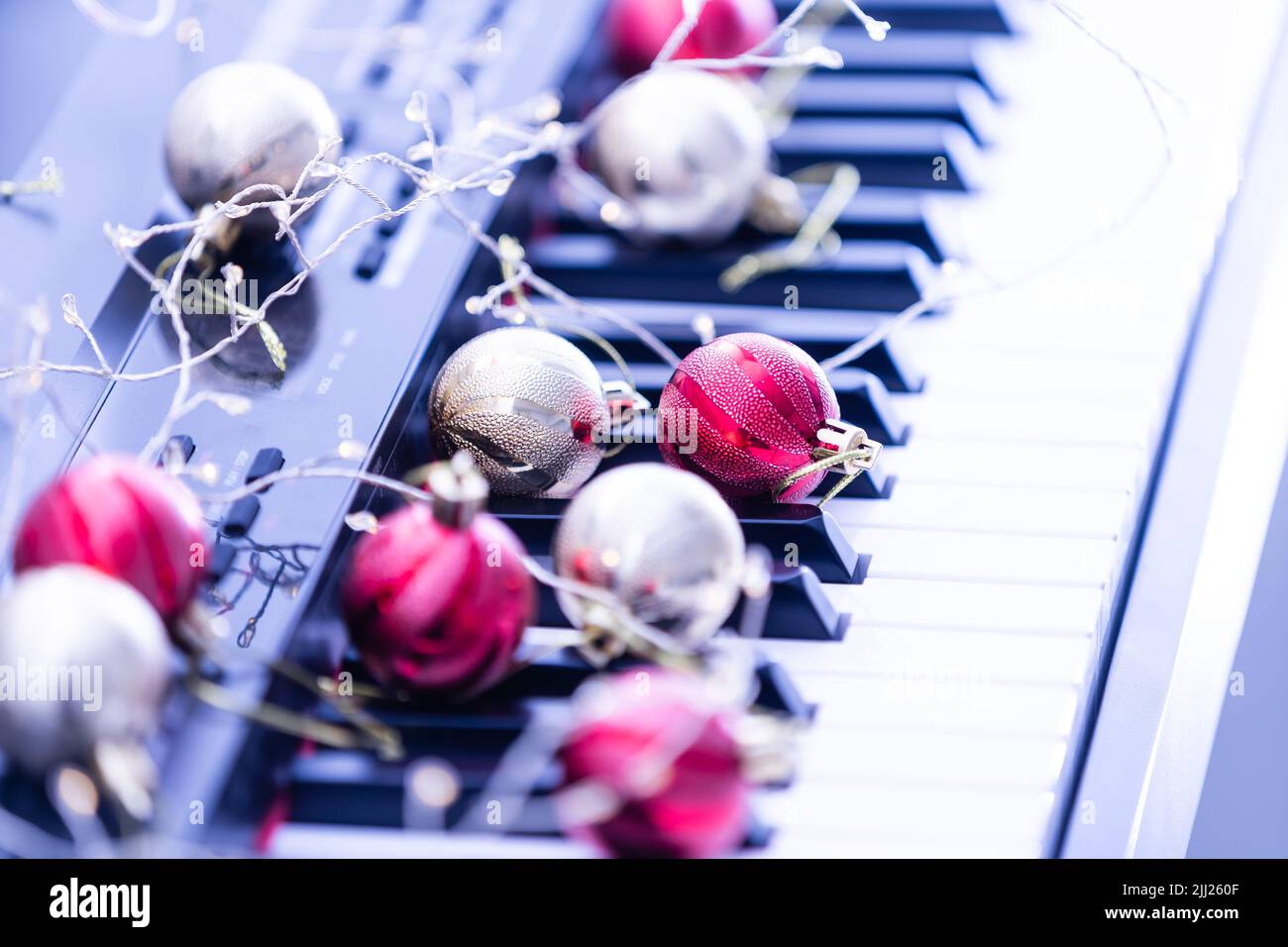 A colorful chain of lights lies on piano keys Stock Photo - Alamy