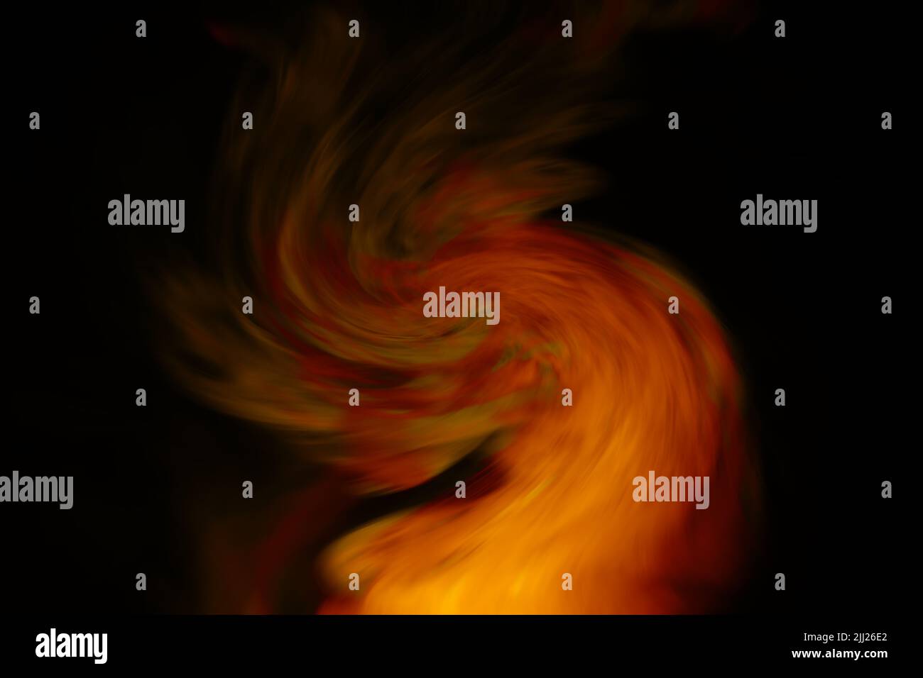 Curling clouds of orange with red smoke on a black background. An ...