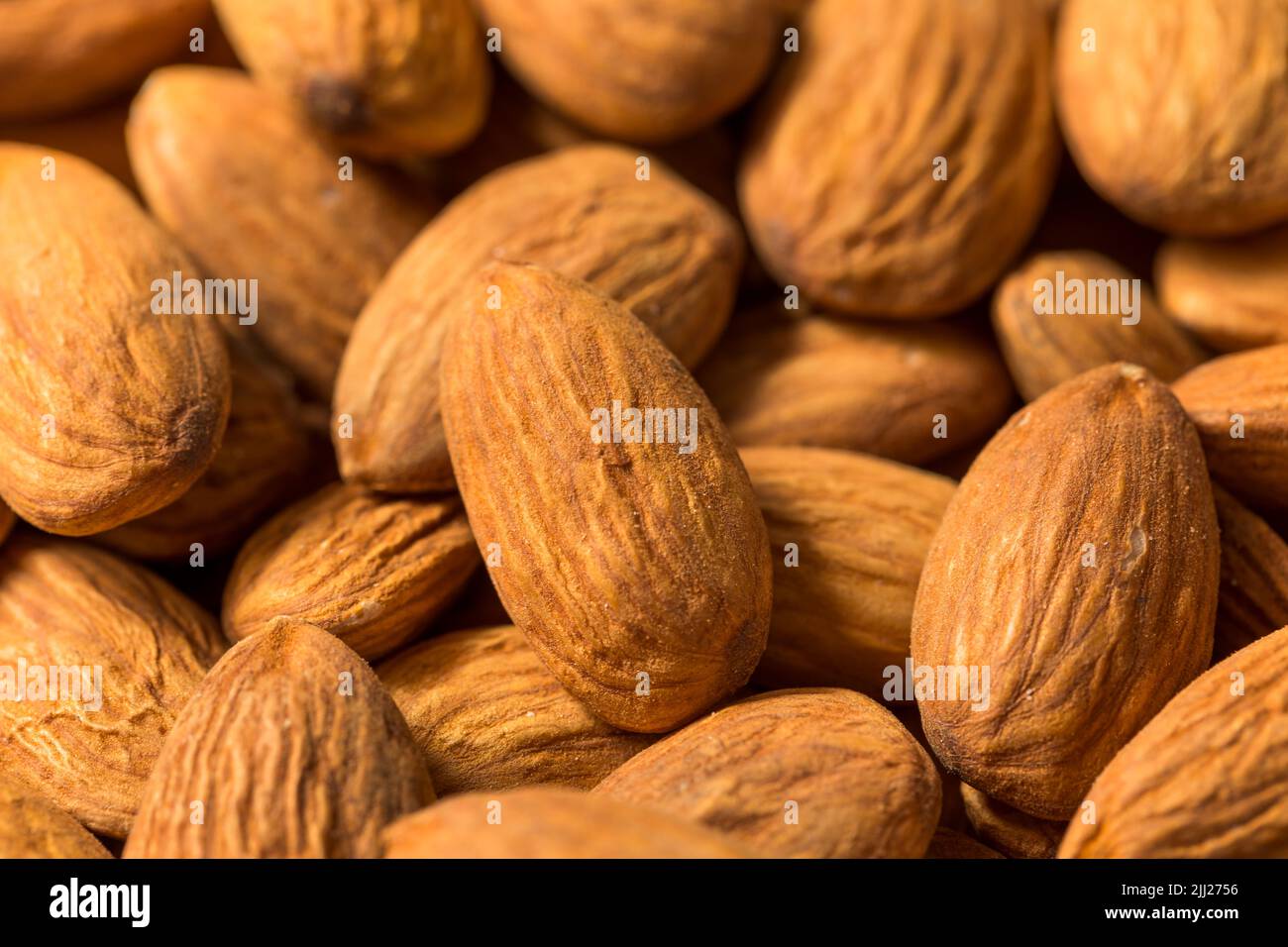 Raw Organic Brown Almonds in a Bowl Stock Photo - Alamy