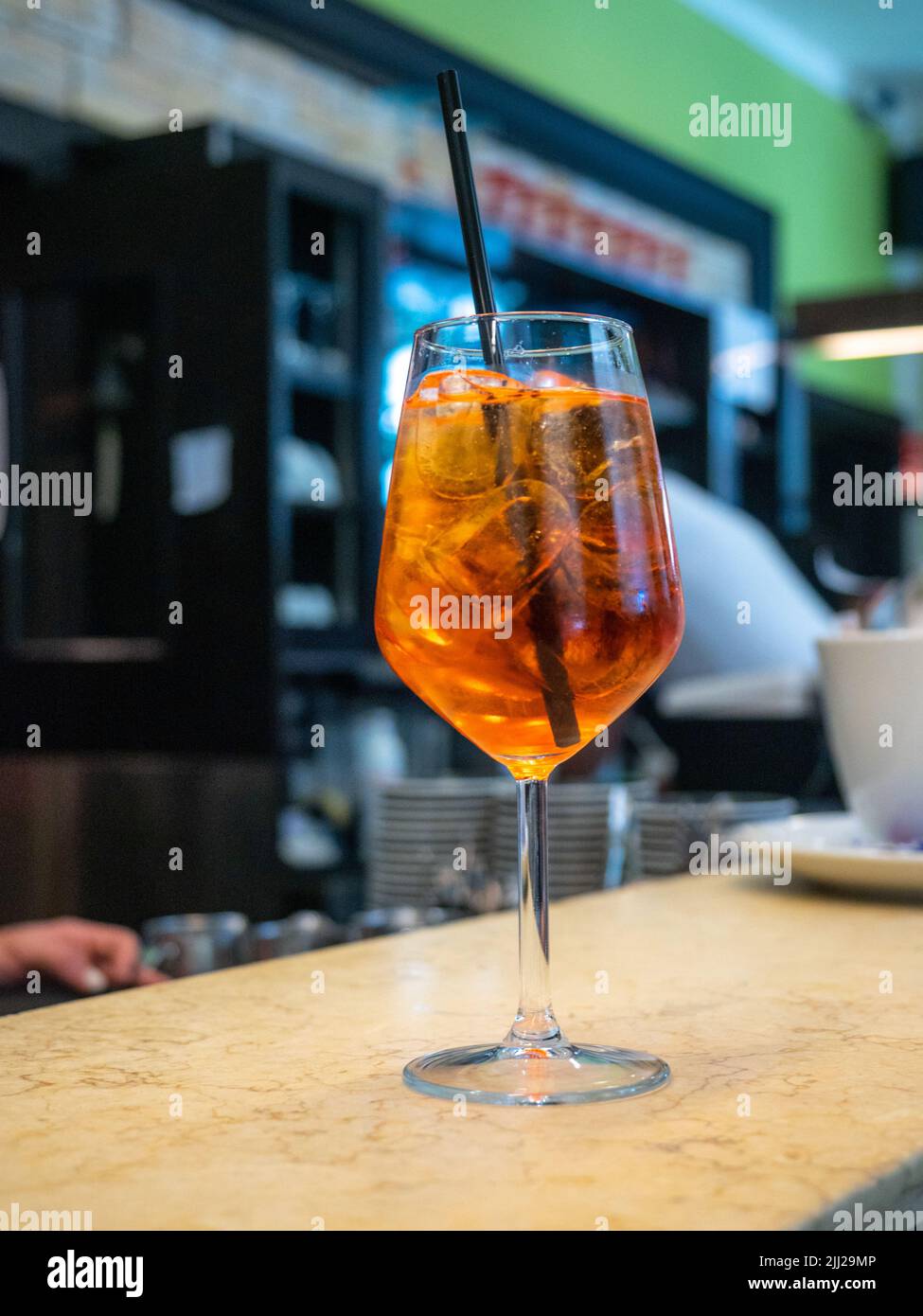 Closeup glass of spritz aperol cocktail decorated with orange at bright ...