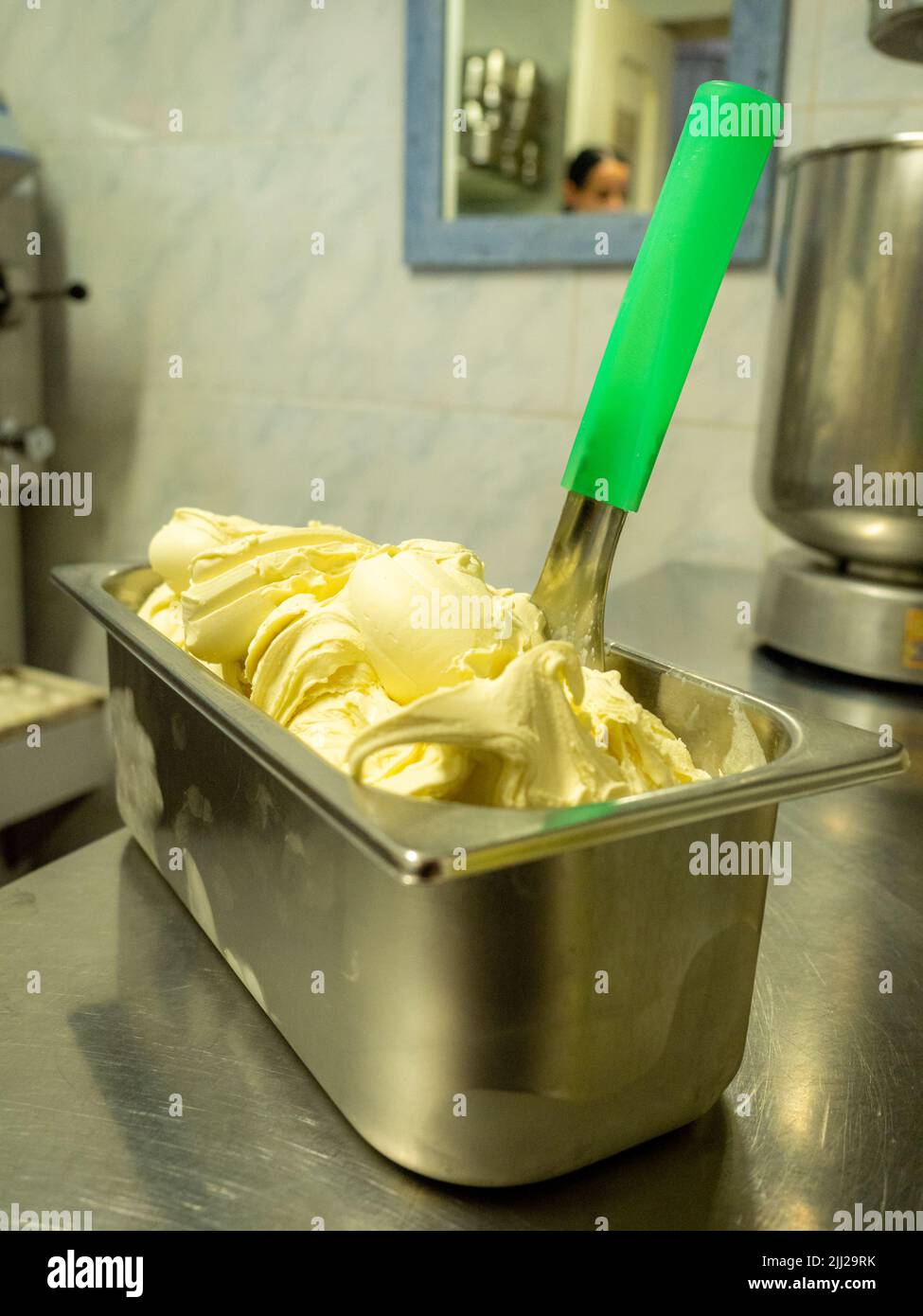 Producing cream ice cream flavors into steel container. Industrial ...