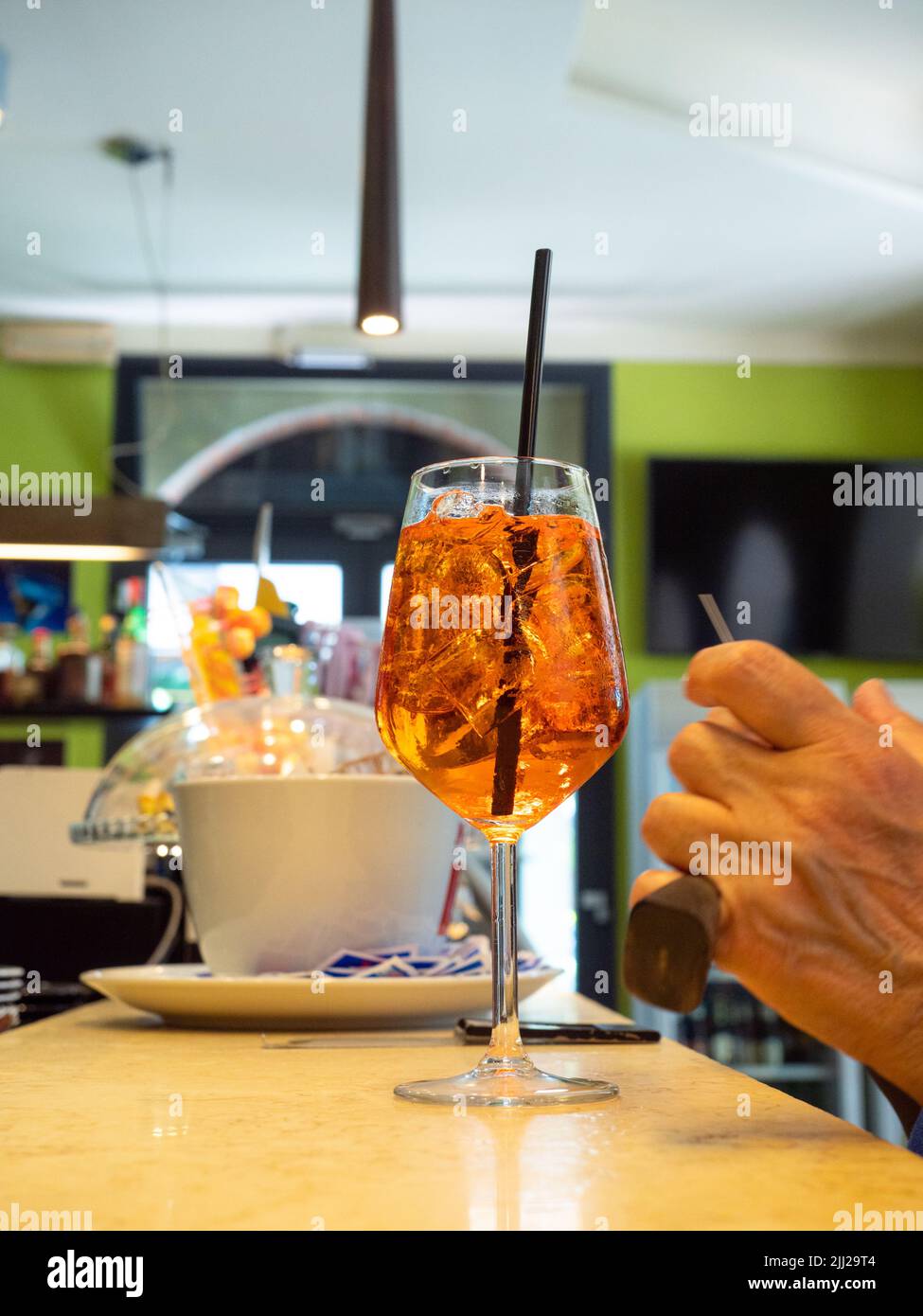 Closeup glass of spritz aperol cocktail decorated with orange at bright ...