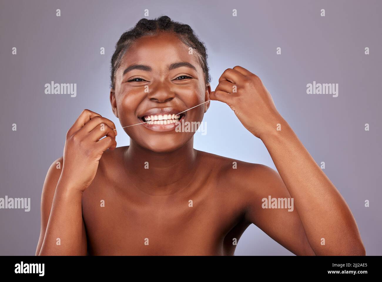Flossing to reach all those in between spots. a young woman flossing ...