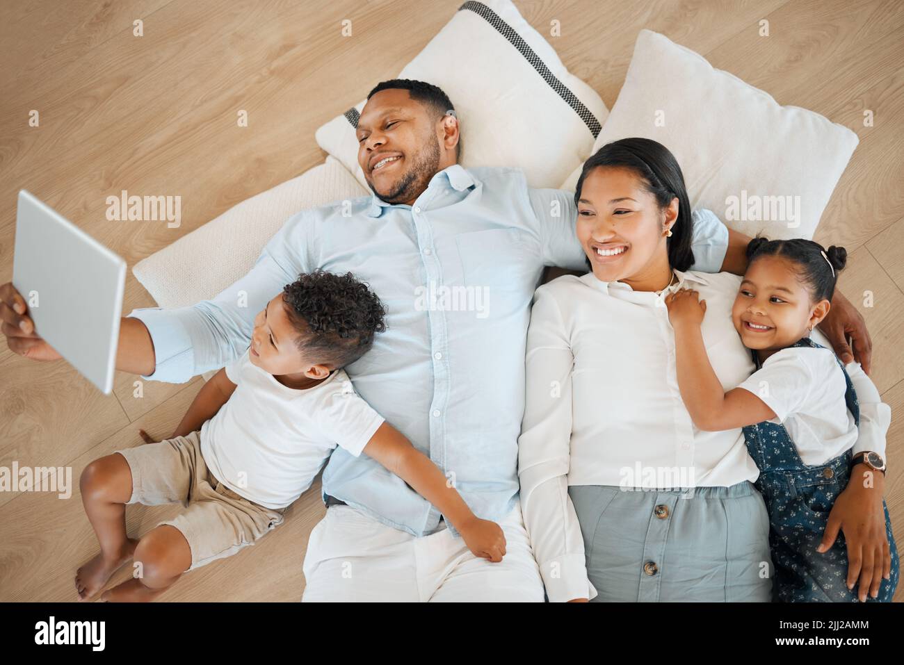 Family gives you the roots to stand tall and strong. a family laying on ...