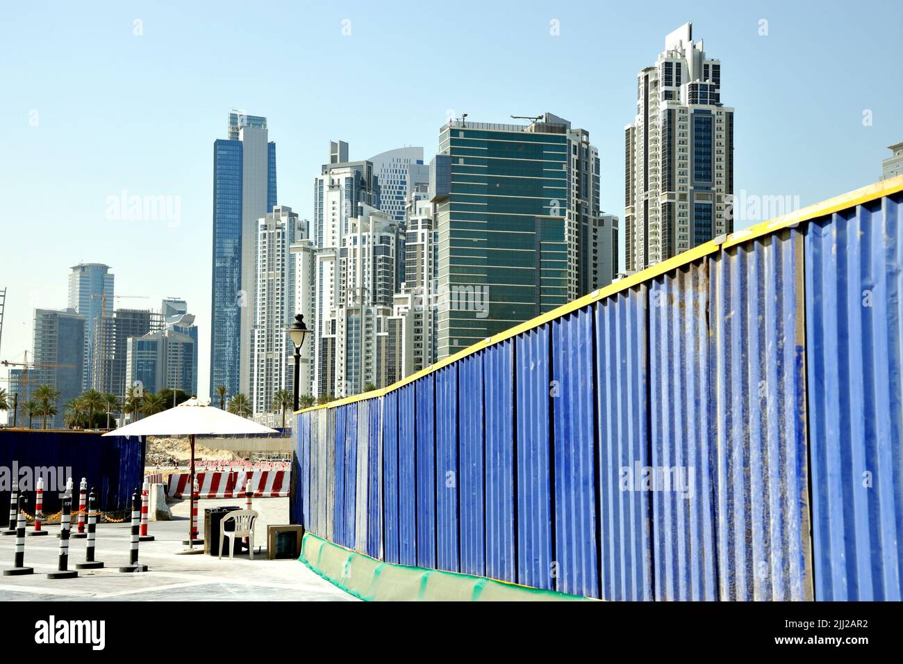 Building construction site in Dubai city. The site is protected with a iron wall Stock Photo - Alamy