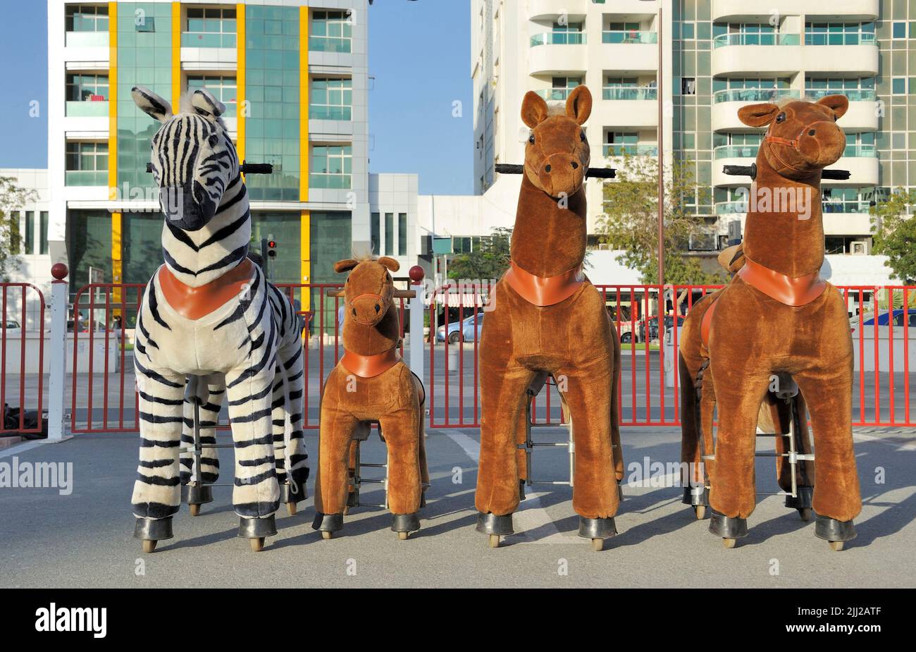Public kid's playground with big animals to ride on in Dubai city Stock ...