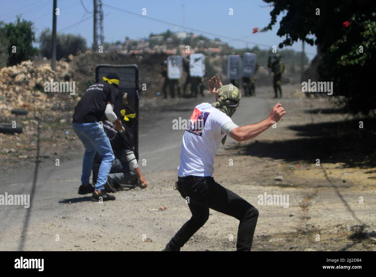 A Palestinian protester runs for cover after being shot by Israeli ...