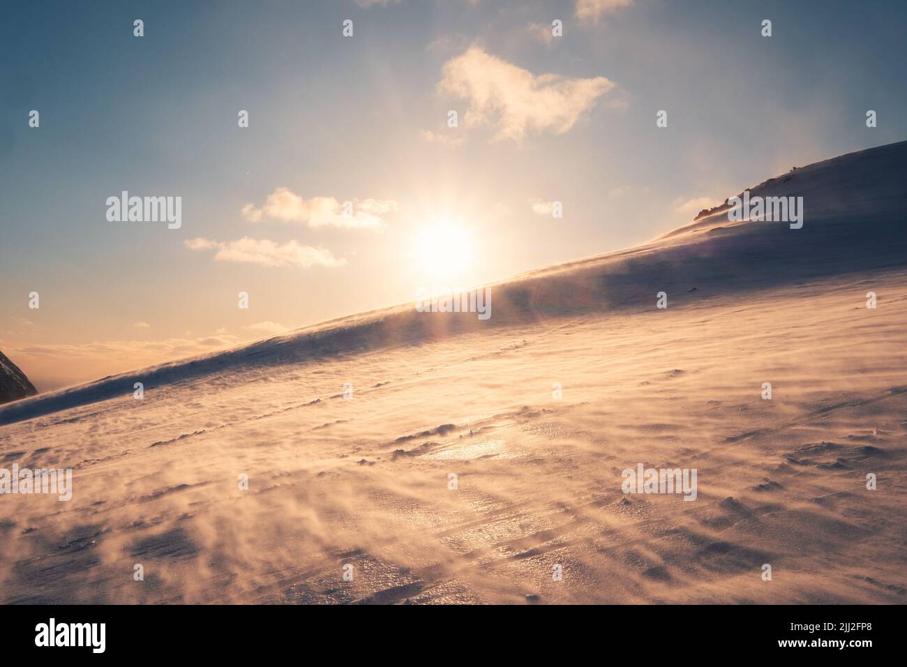 Beautiful sunset over snowy mountain and windy on Mount Ryten, Lofoten ...