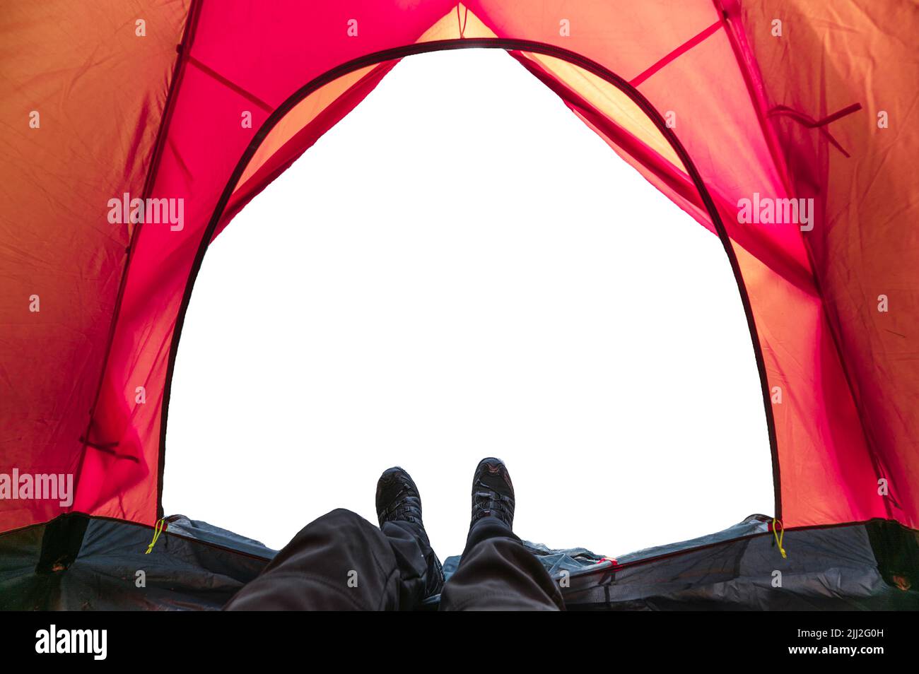 Hiker man wearing boot relaxing inside a red tent on empty white ...