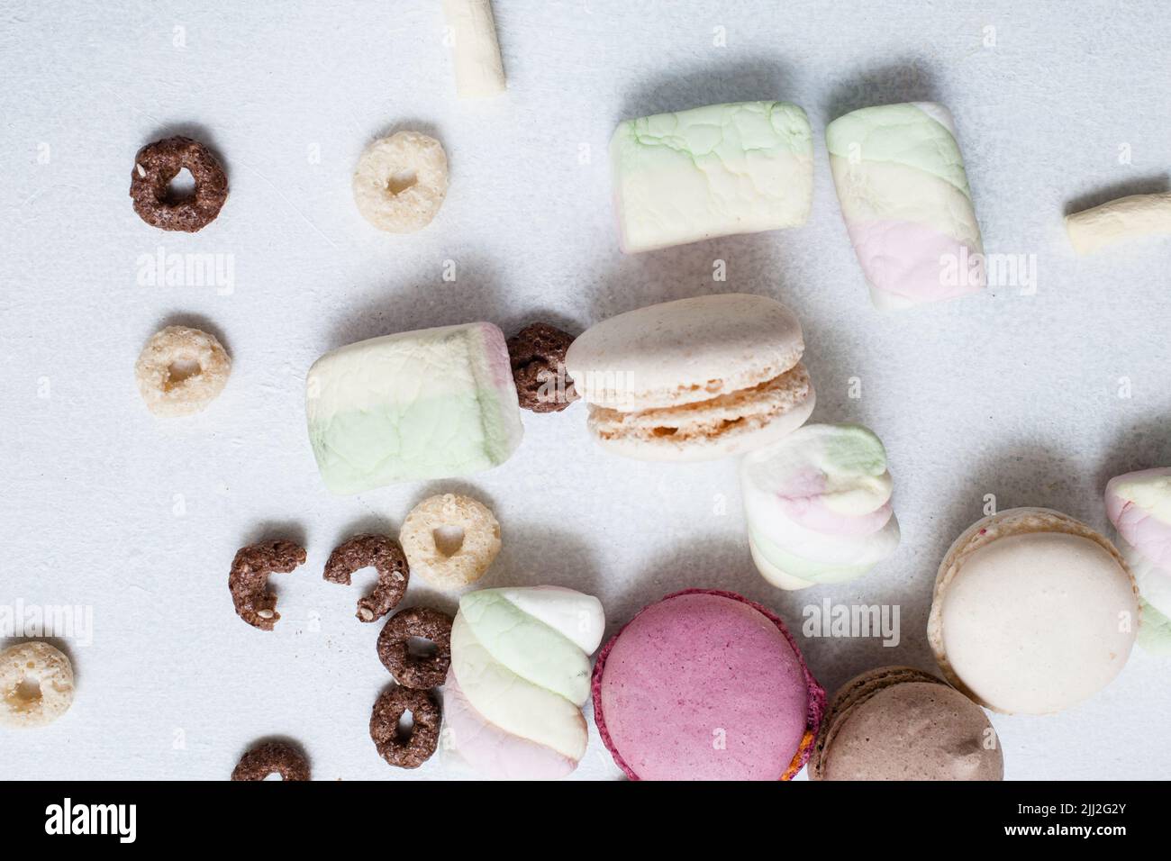 Colorful sweets on white background top view Stock Photo - Alamy