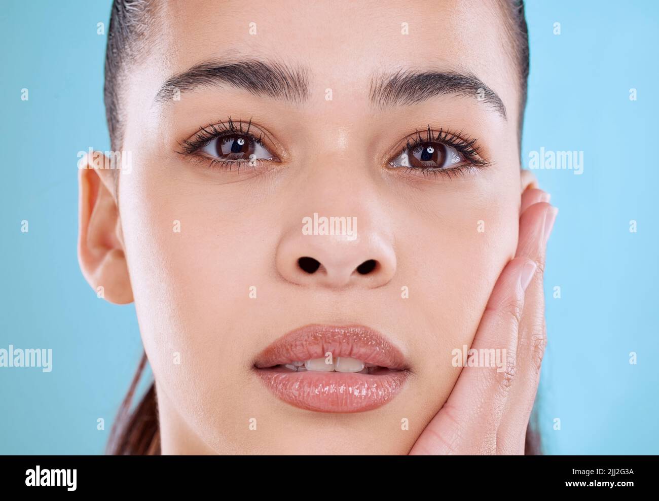 Beauty has a new face. Studio portrait of an attractive young woman posing against a blue ...