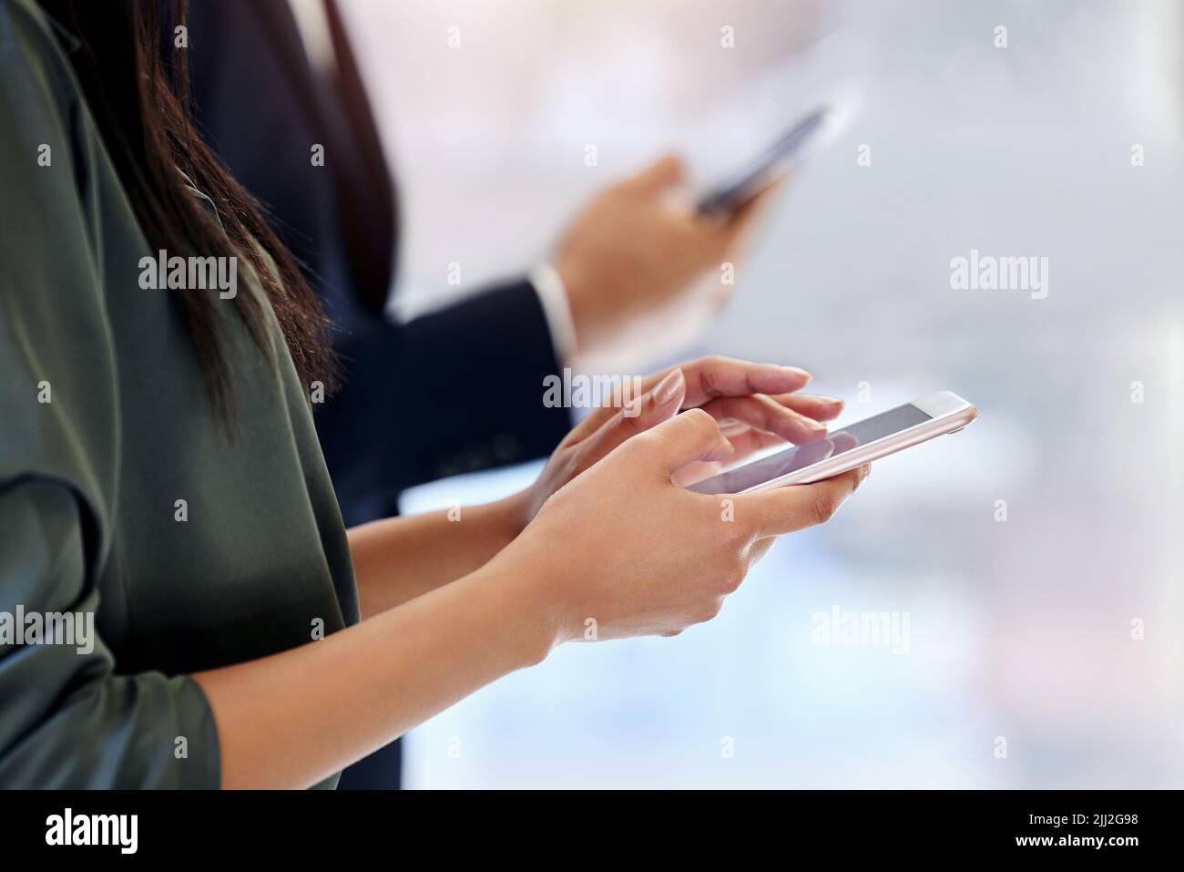 All you need to do is tap. two unrecognizable businesspeople using ...