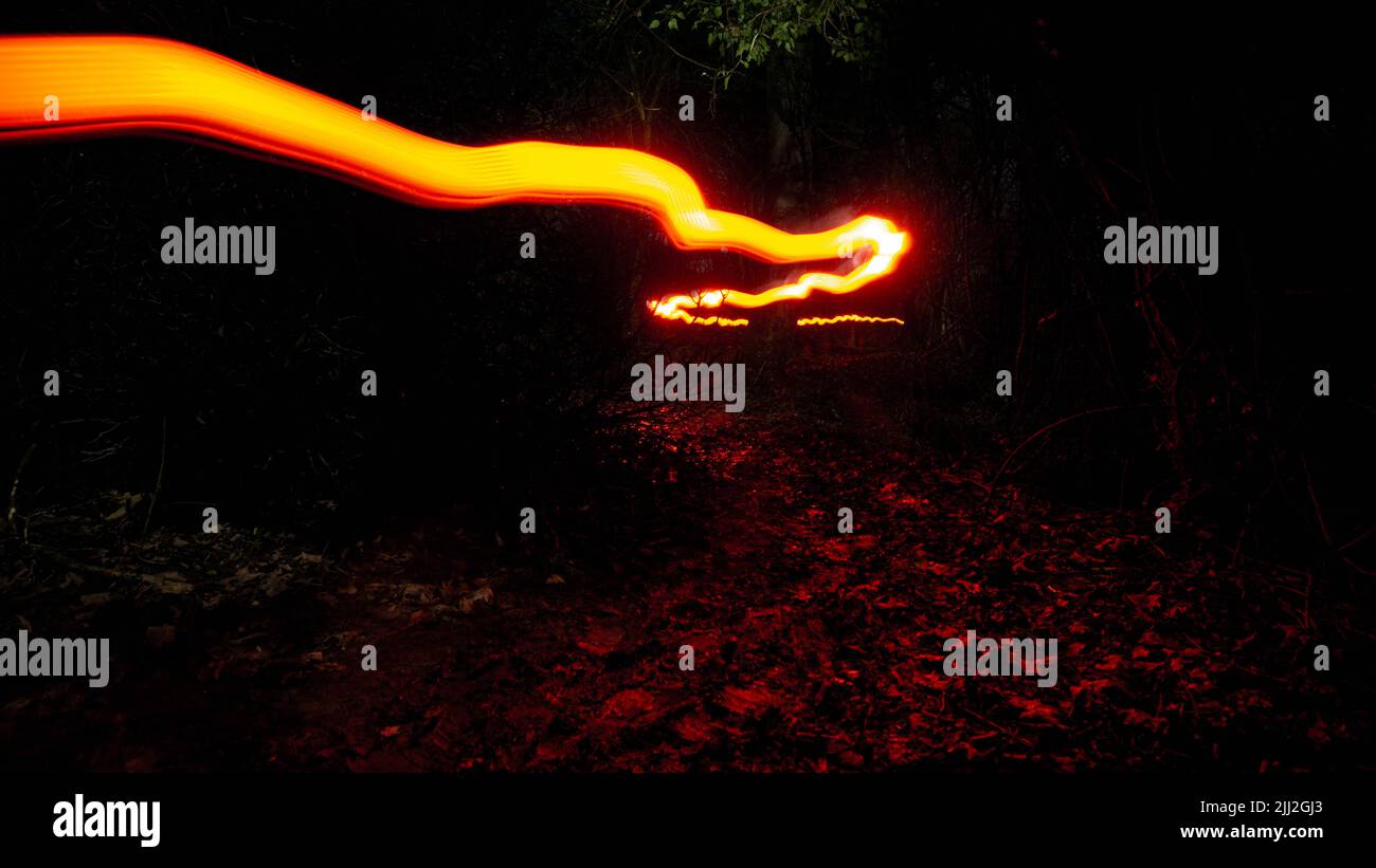 Red light trail through a woodland Stock Photo - Alamy