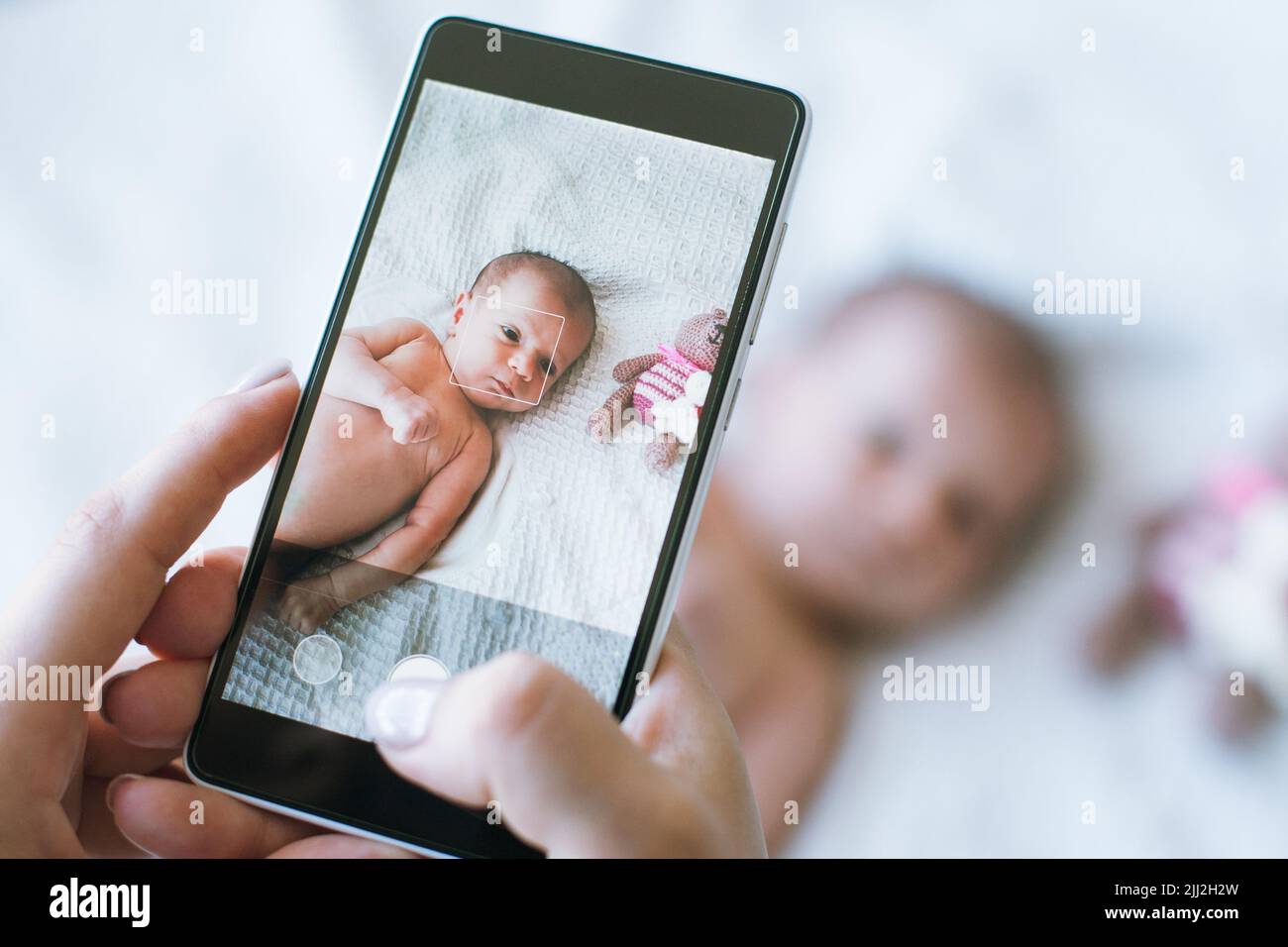 mother take a smartphone photo of her newborn baby Stock Photo - Alamy