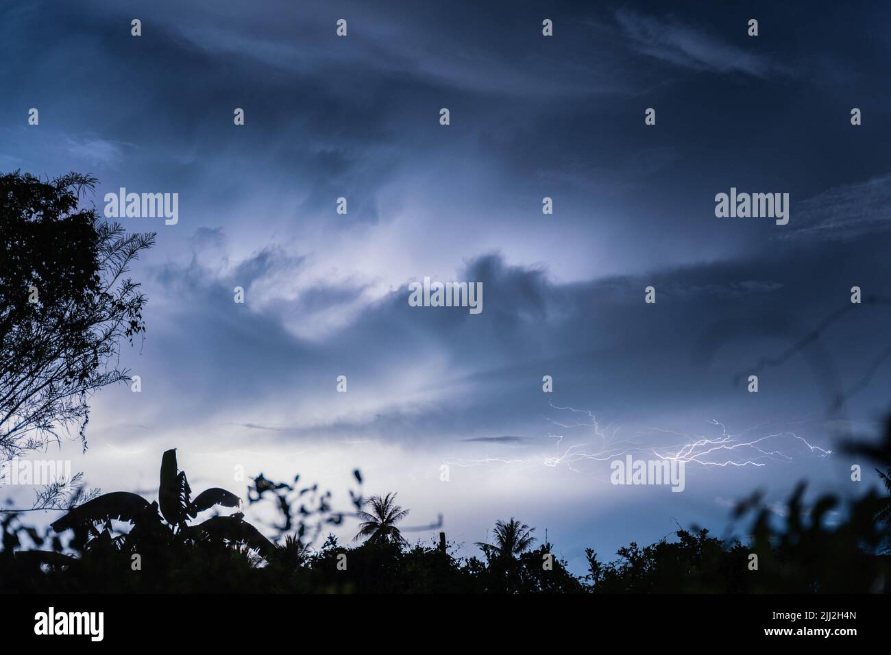 Dramatic lightning thunderstorm striking in the night sky over rural ...