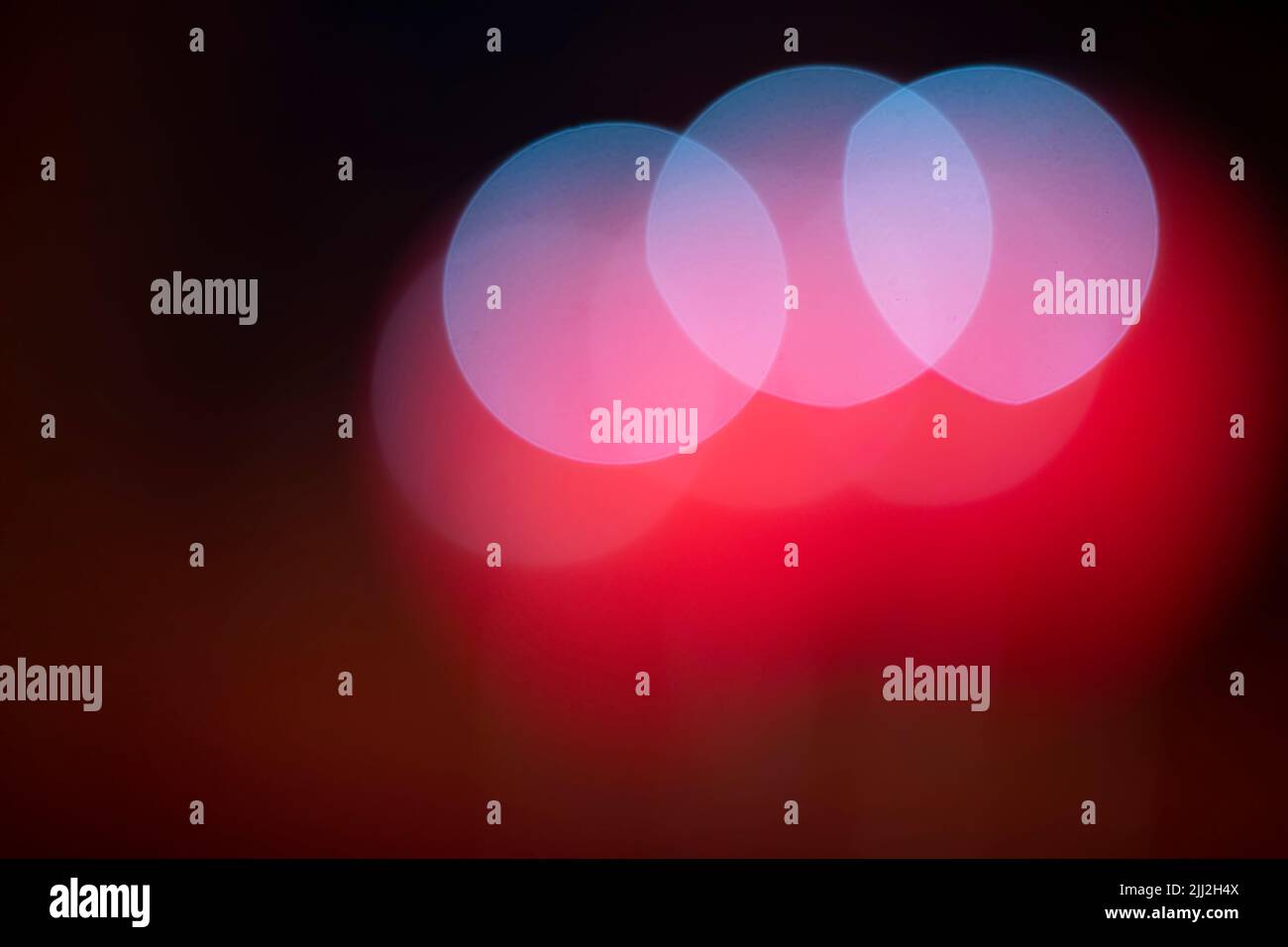 Large spots of bokeh on a red background Stock Photo - Alamy