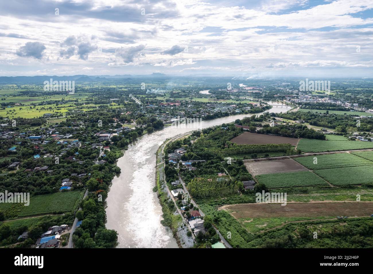 Aerial view of curved large river and village living by the water and ...
