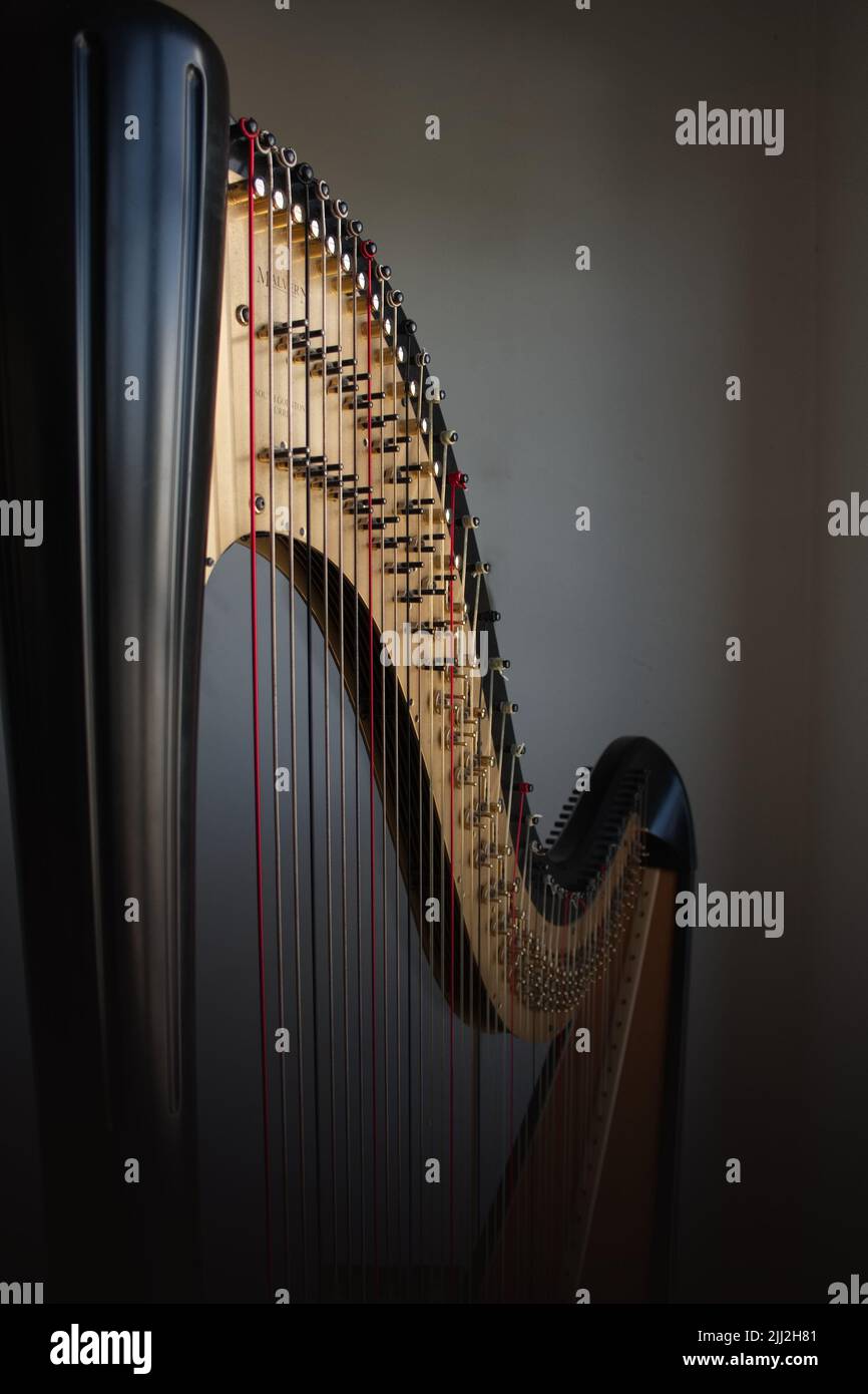 Melodious muse: A graceful harp, ready to weave its magic Stock Photo ...