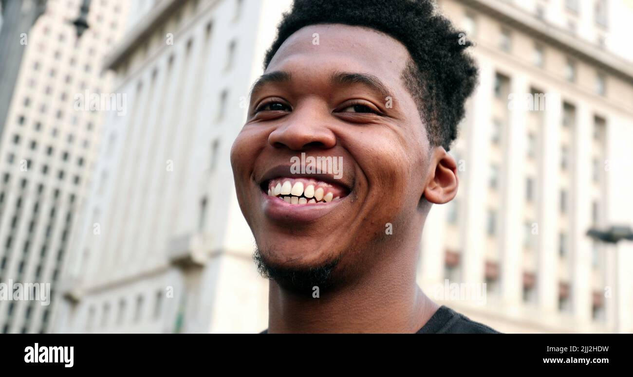 African black man smiling and laughing outside, real authentic people ...