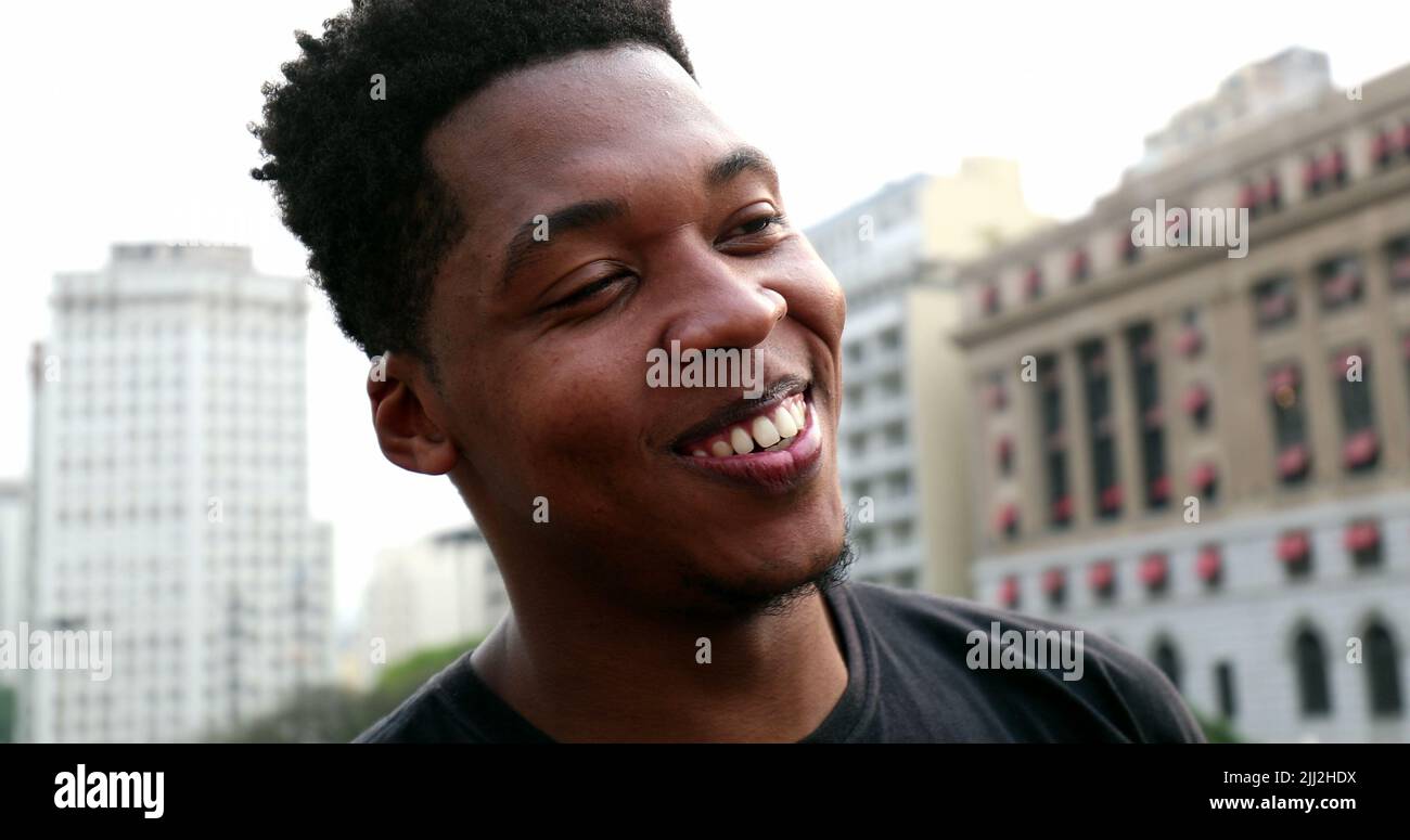 African black man smiling and laughing outside, real authentic people ...