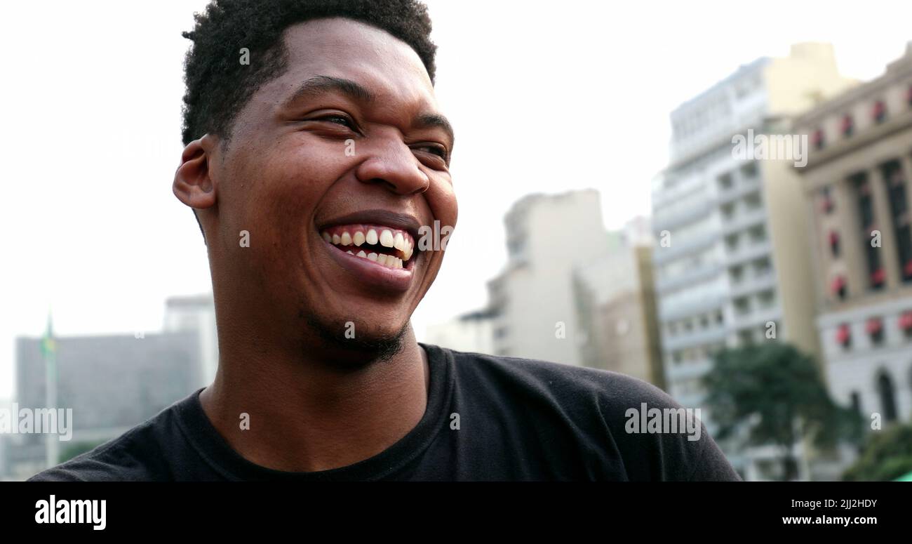 African black man smiling and laughing outside, real authentic people ...