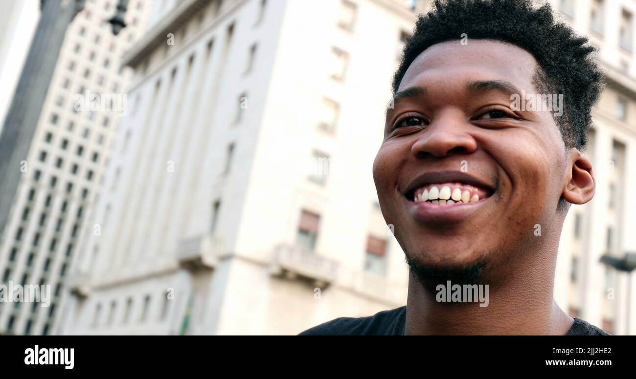 African black man smiling and laughing outside, real authentic people ...