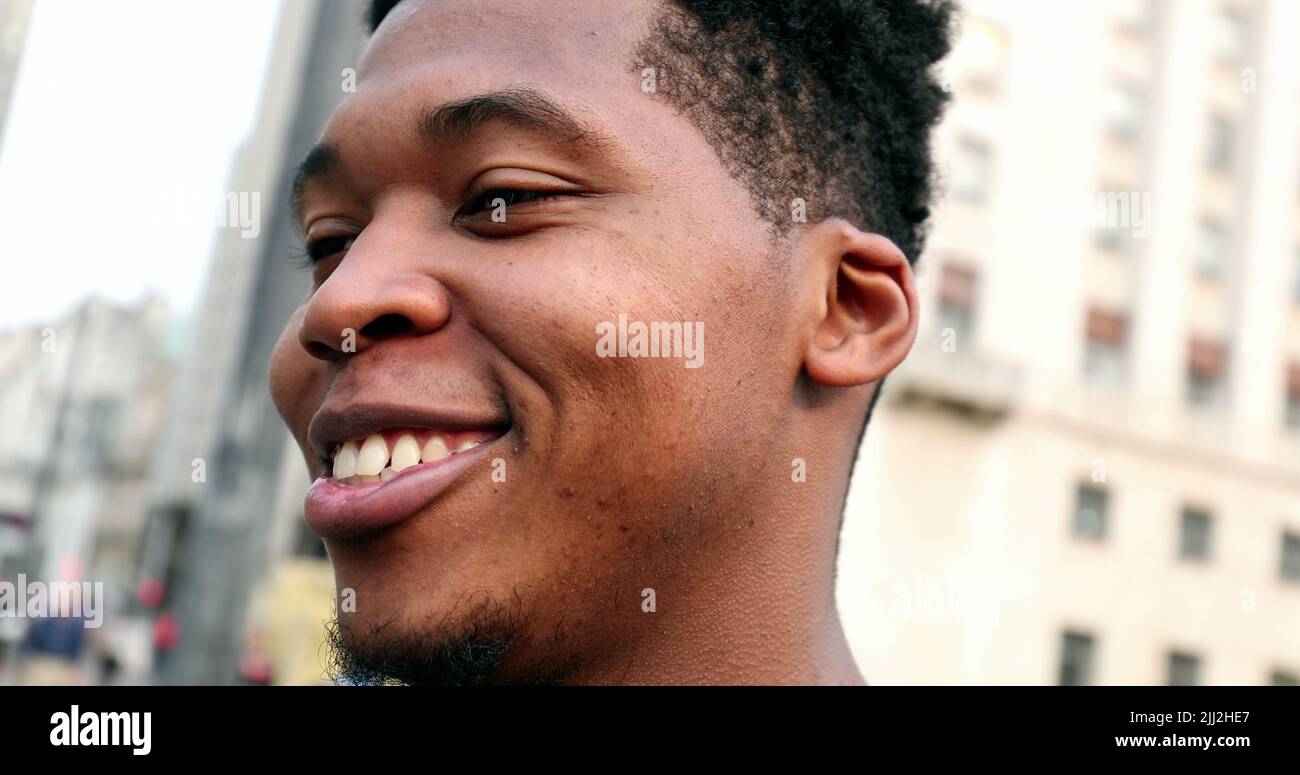 African black man smiling and laughing outside, real authentic people ...