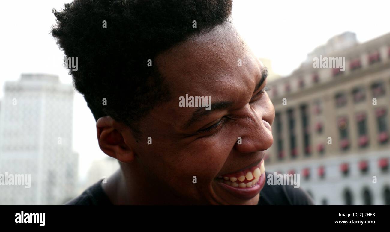African black man smiling and laughing outside, real authentic people ...