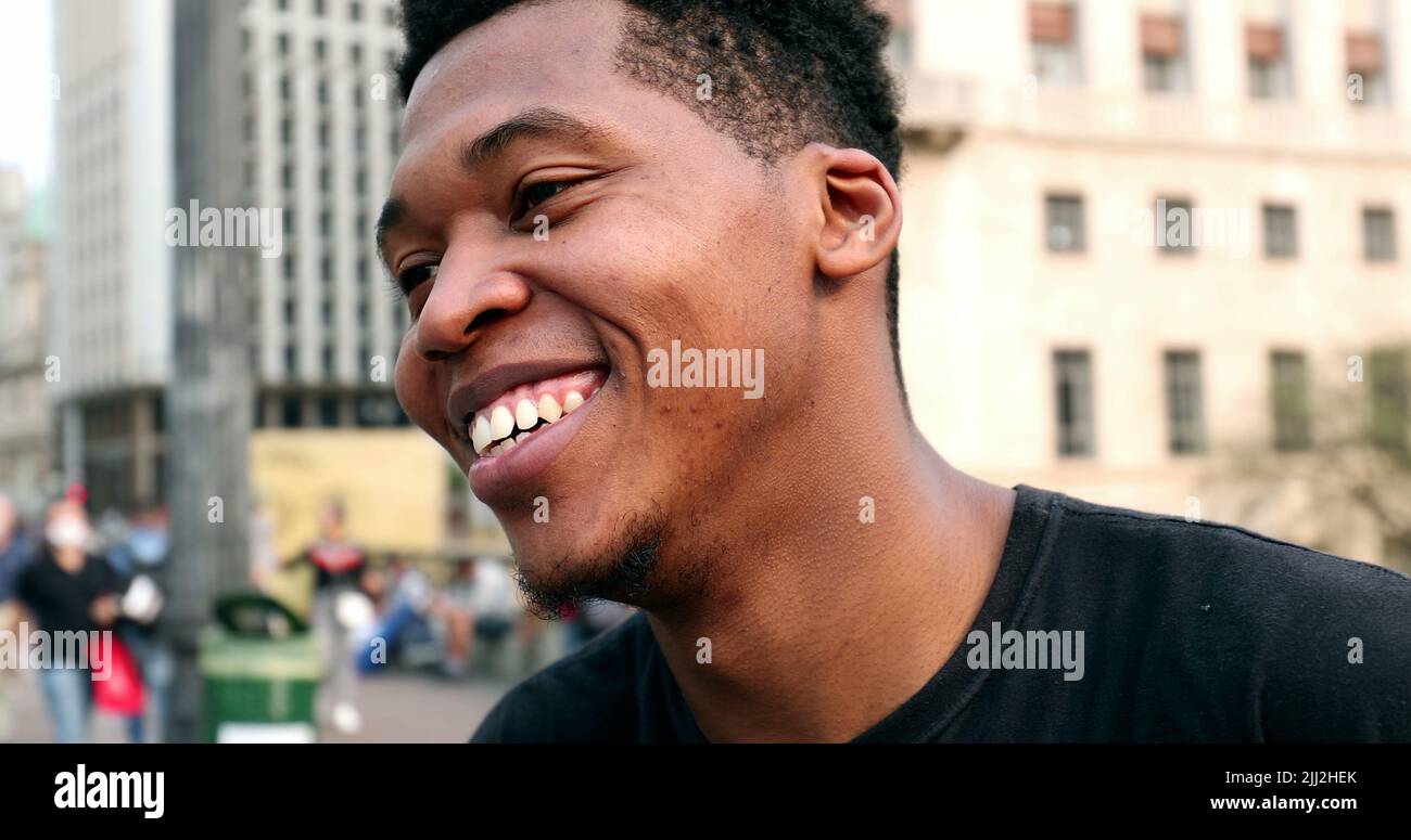 African black man smiling and laughing outside, real authentic people ...