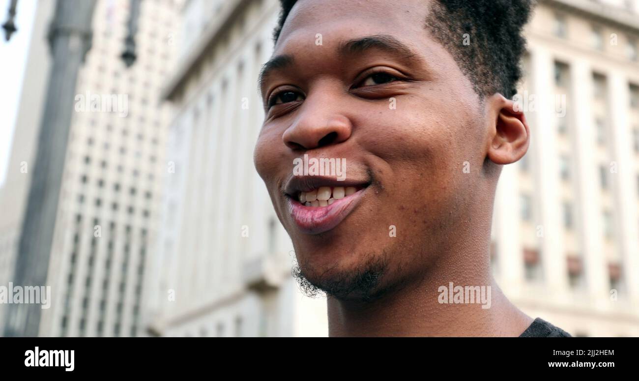 African black man smiling and laughing outside, real authentic people ...