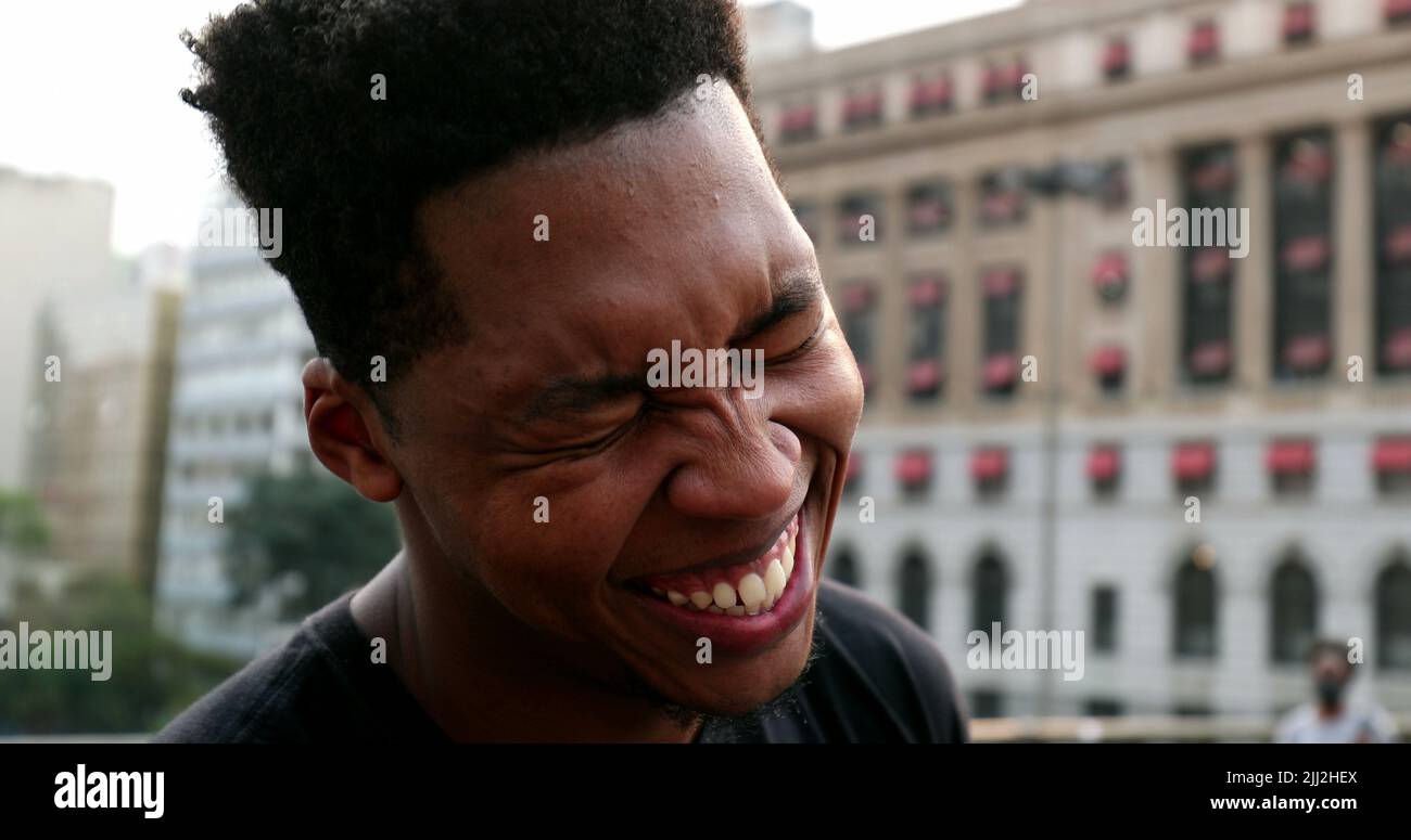 African black man smiling and laughing outside, real authentic people ...