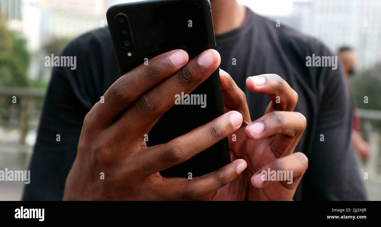 African black man using cellphone in street Stock Photo - Alamy
