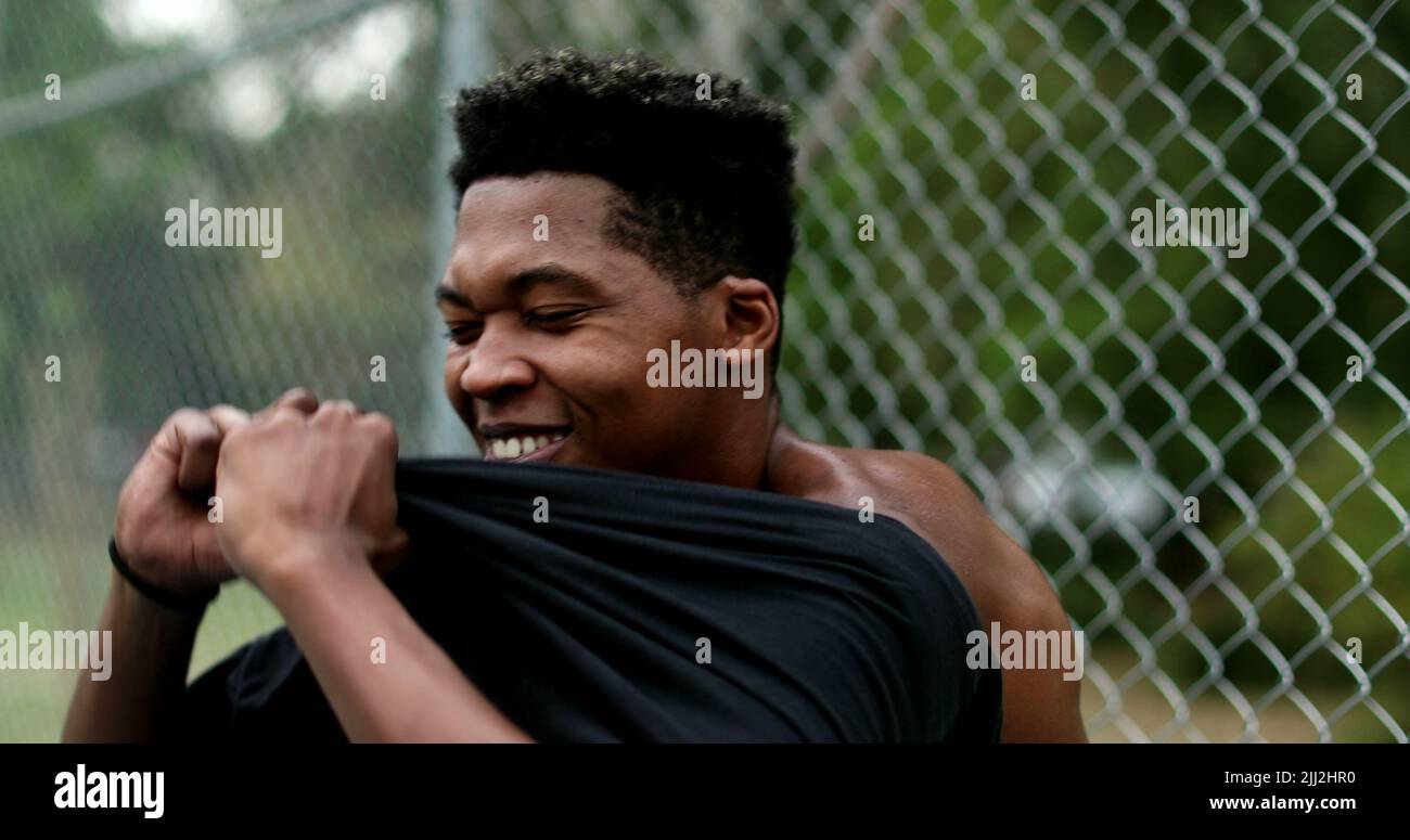 African man putting shirt on hi-res stock photography and images - Alamy